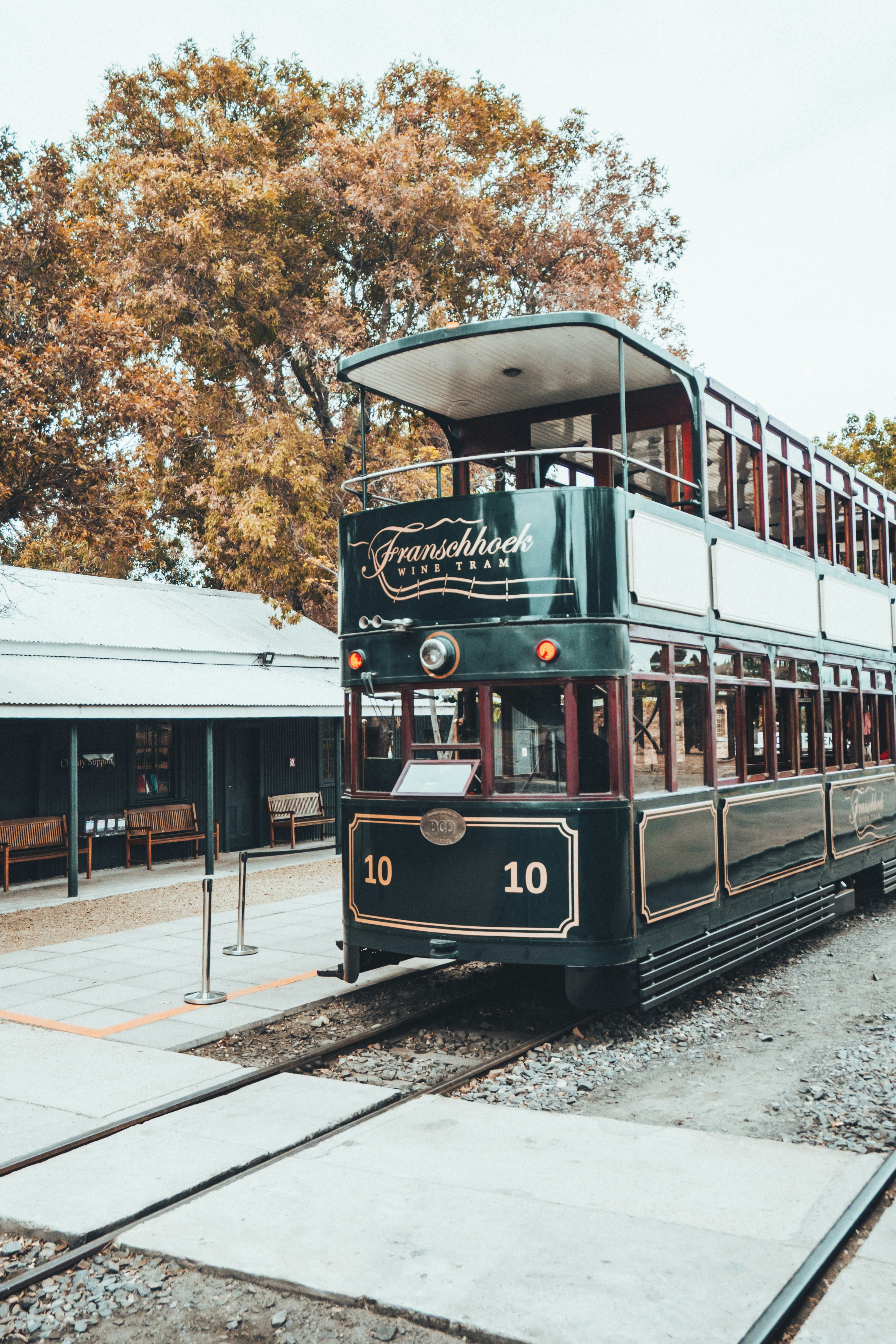 A double-decker trolley is at the station. photo – Free Human Image on ...
