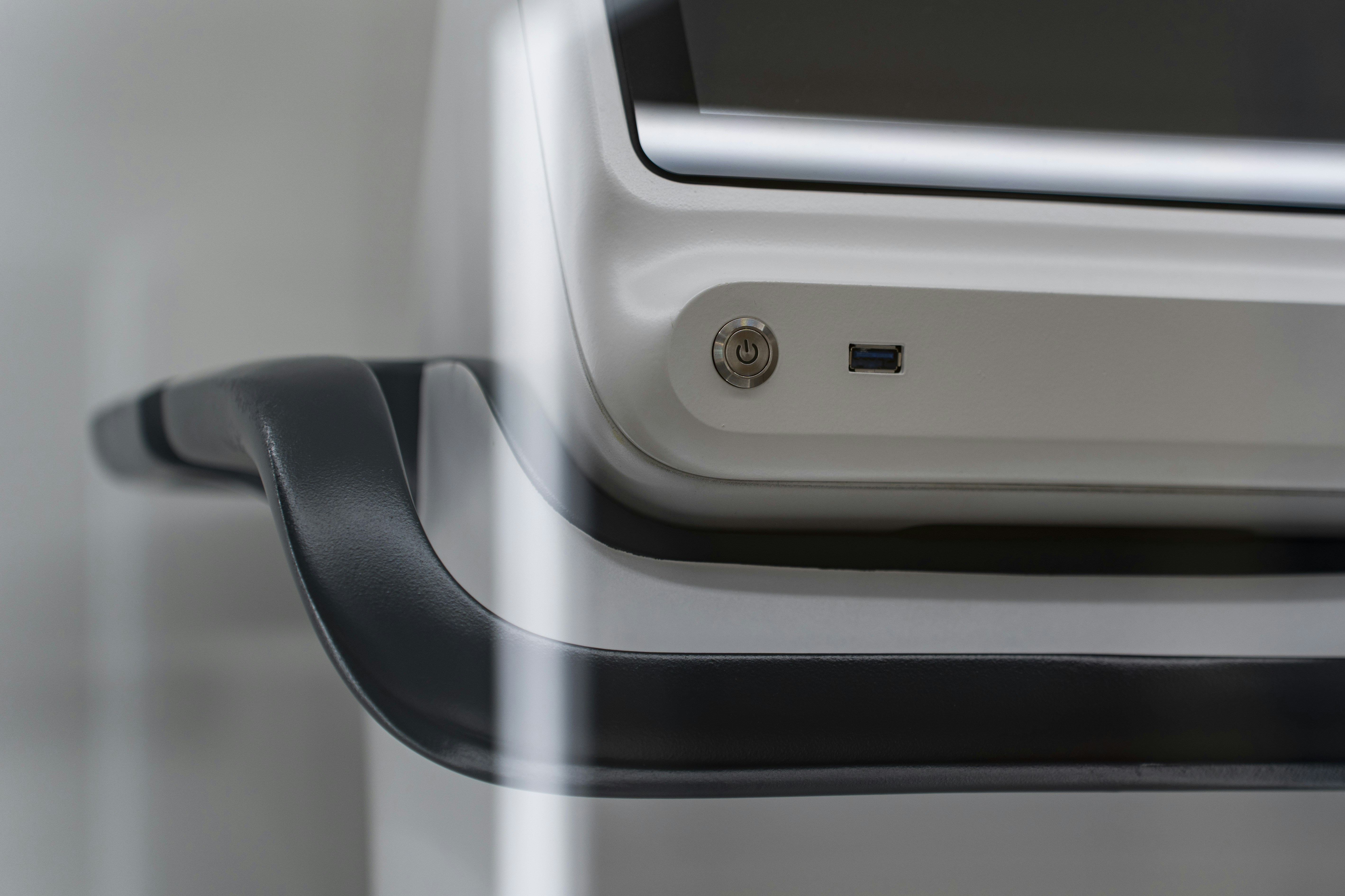 Close-up of a white laptop's side.
