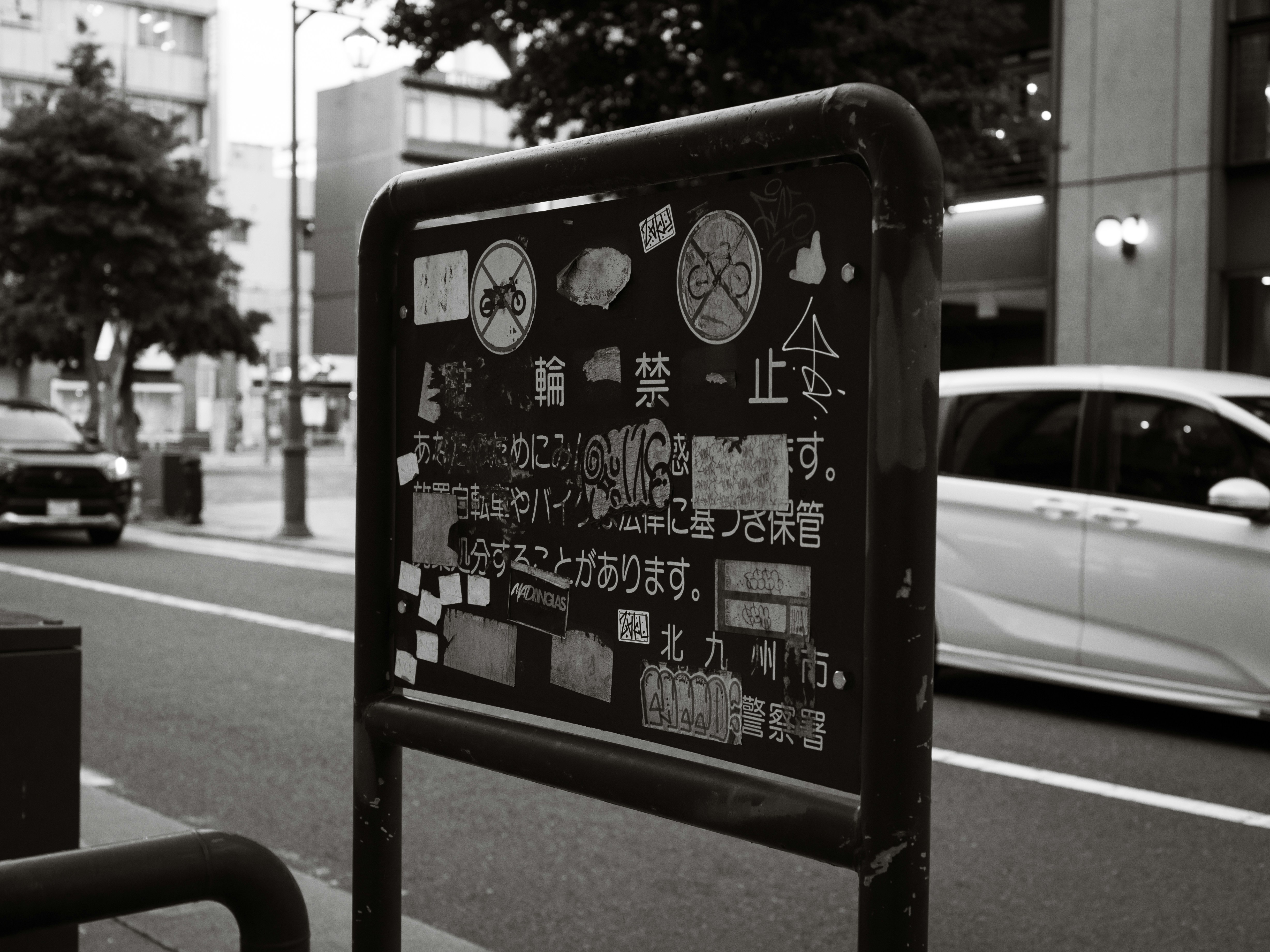 Urban Whispers: A Sign Beneath the Cityscape