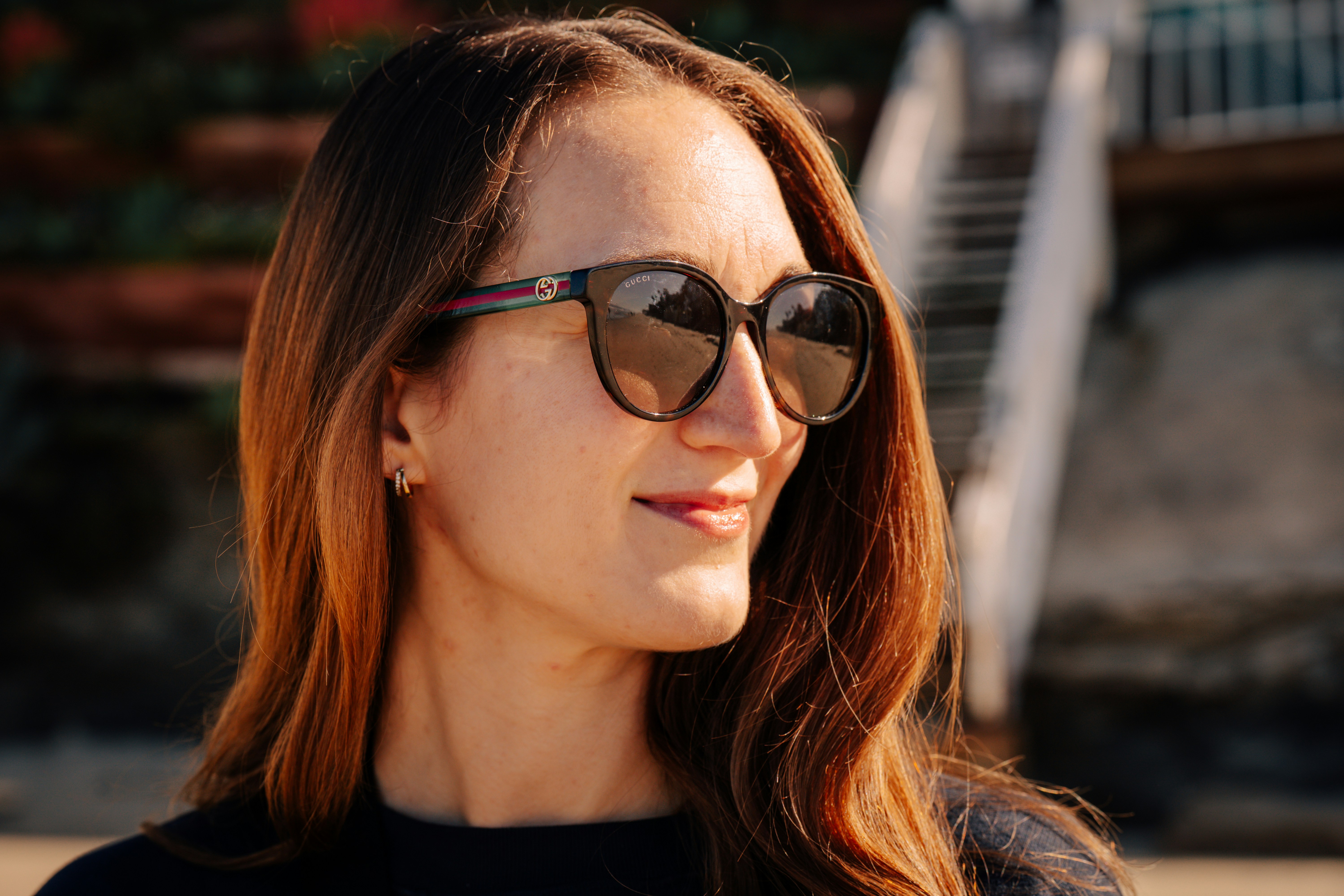 Beautiful woman in Laguna Beach. | Woman wearing sunglasses outdoors, enjoying the sunlight.