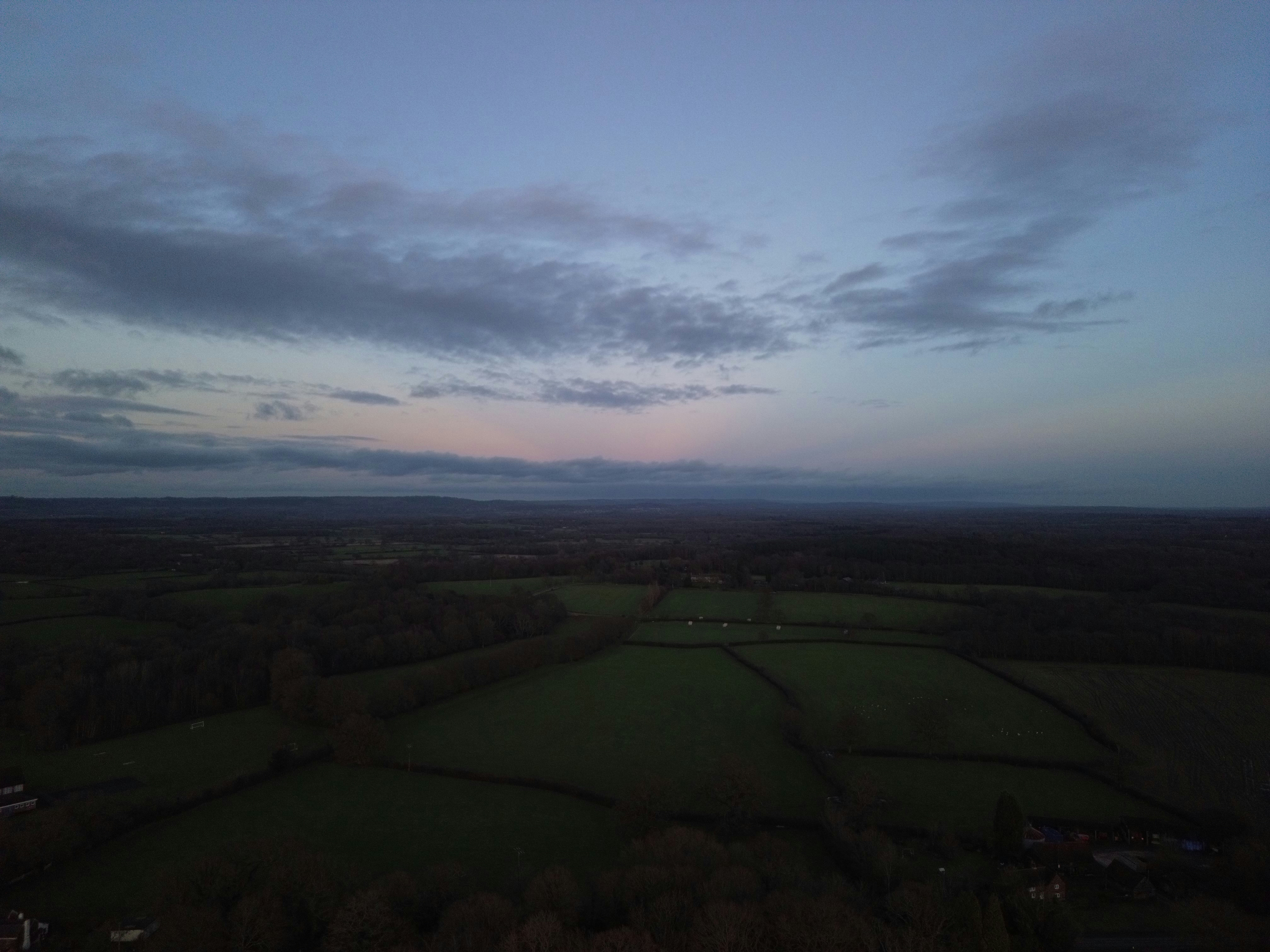 A dusk sky over a green, grassy landscape. photo – Free Forest Image on ...