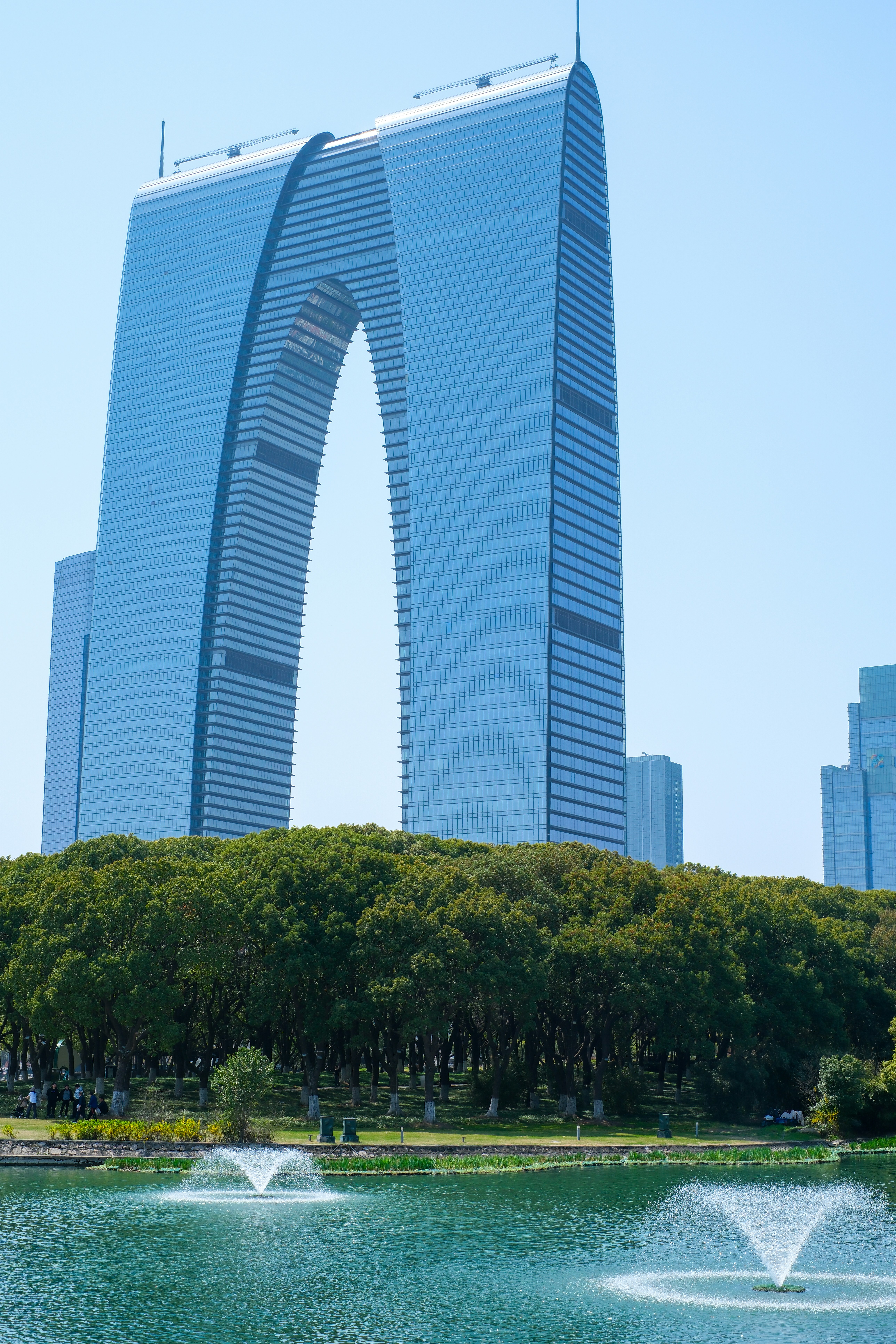 A tall building with an arched opening is visible. photo – Free City ...