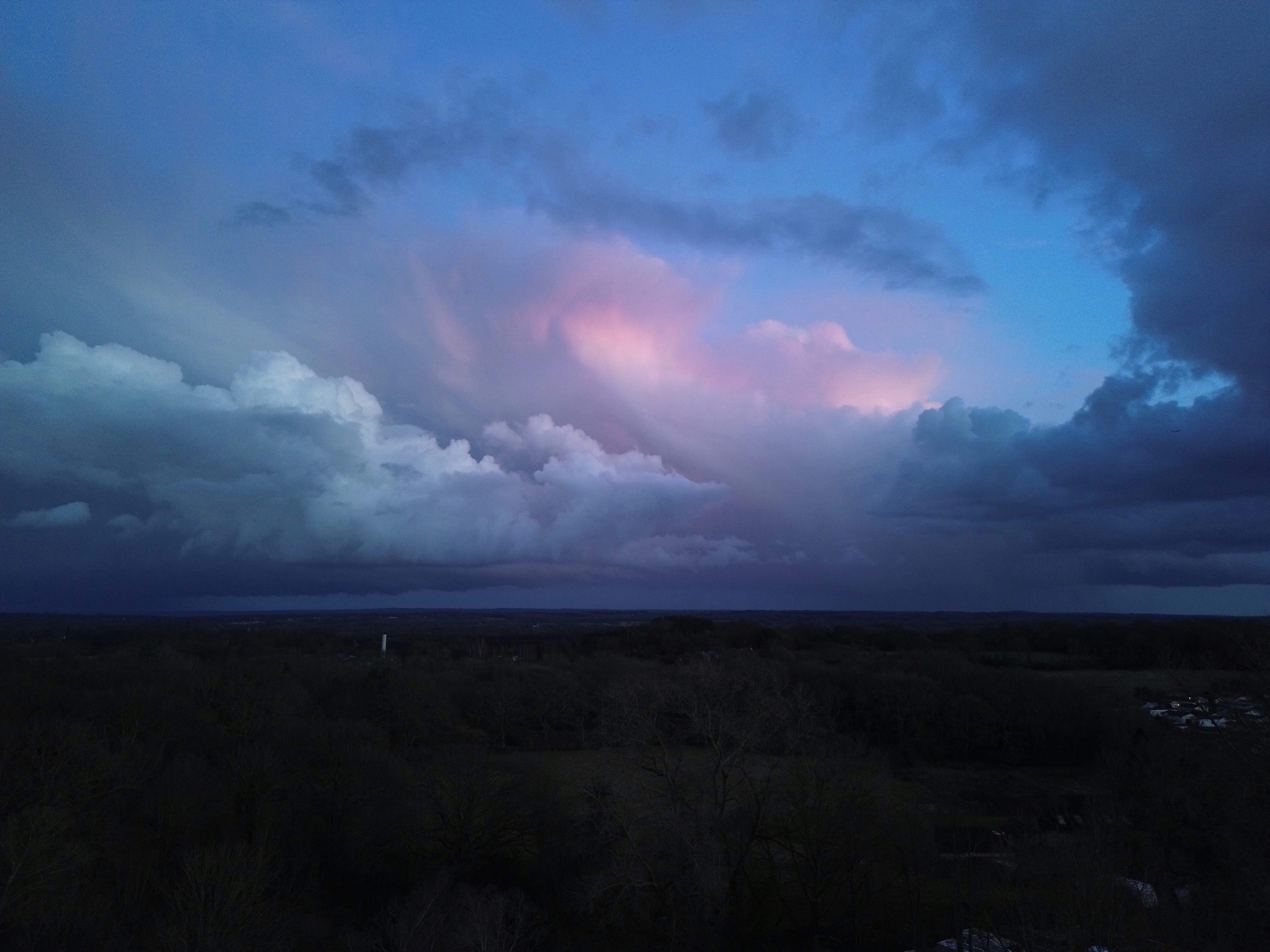Pink Storm Veil Over a Dusky Plain at Blue Hour