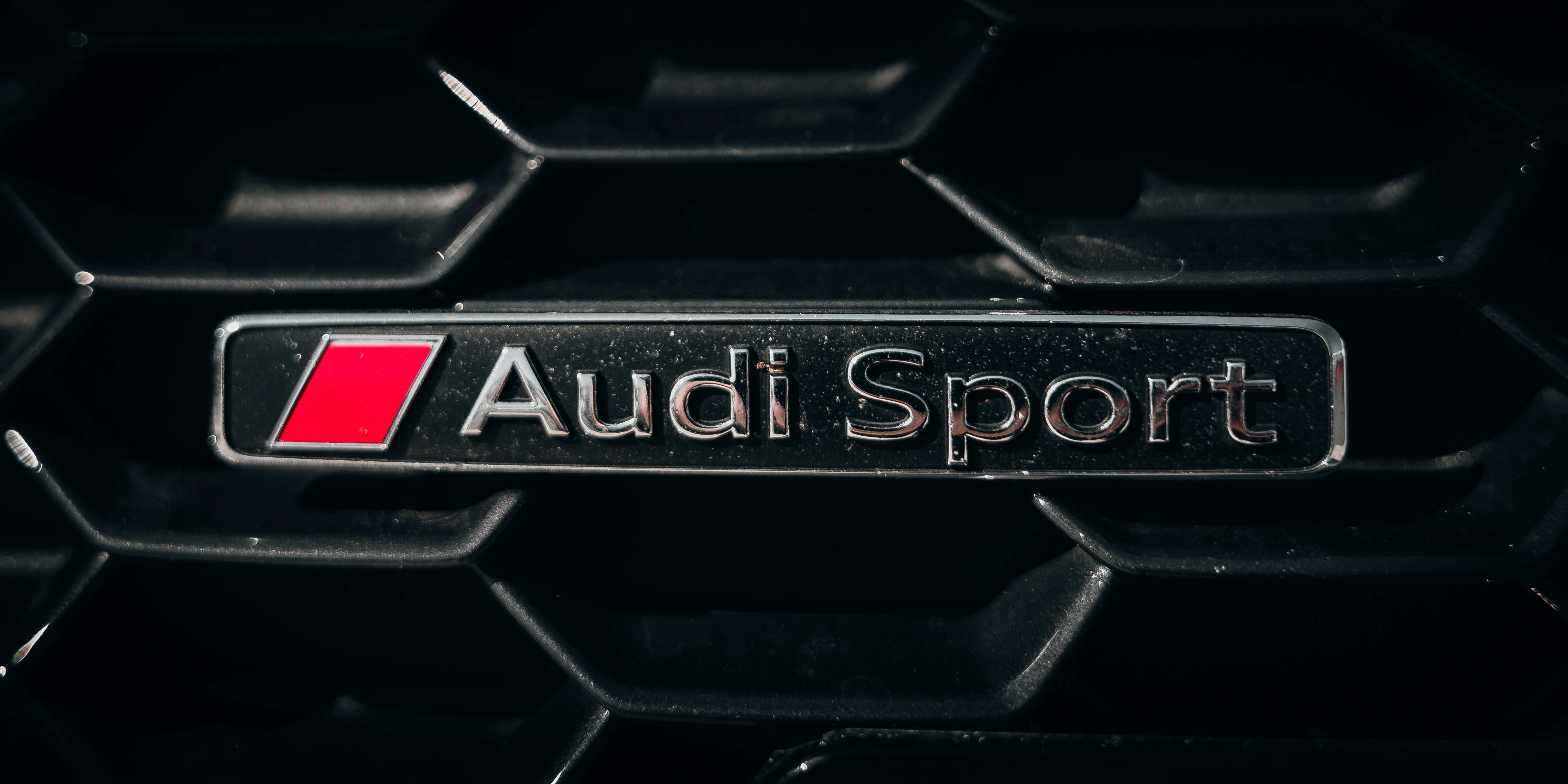 Audi sport emblem on a black honeycomb grille. photo – Free Sports car ...