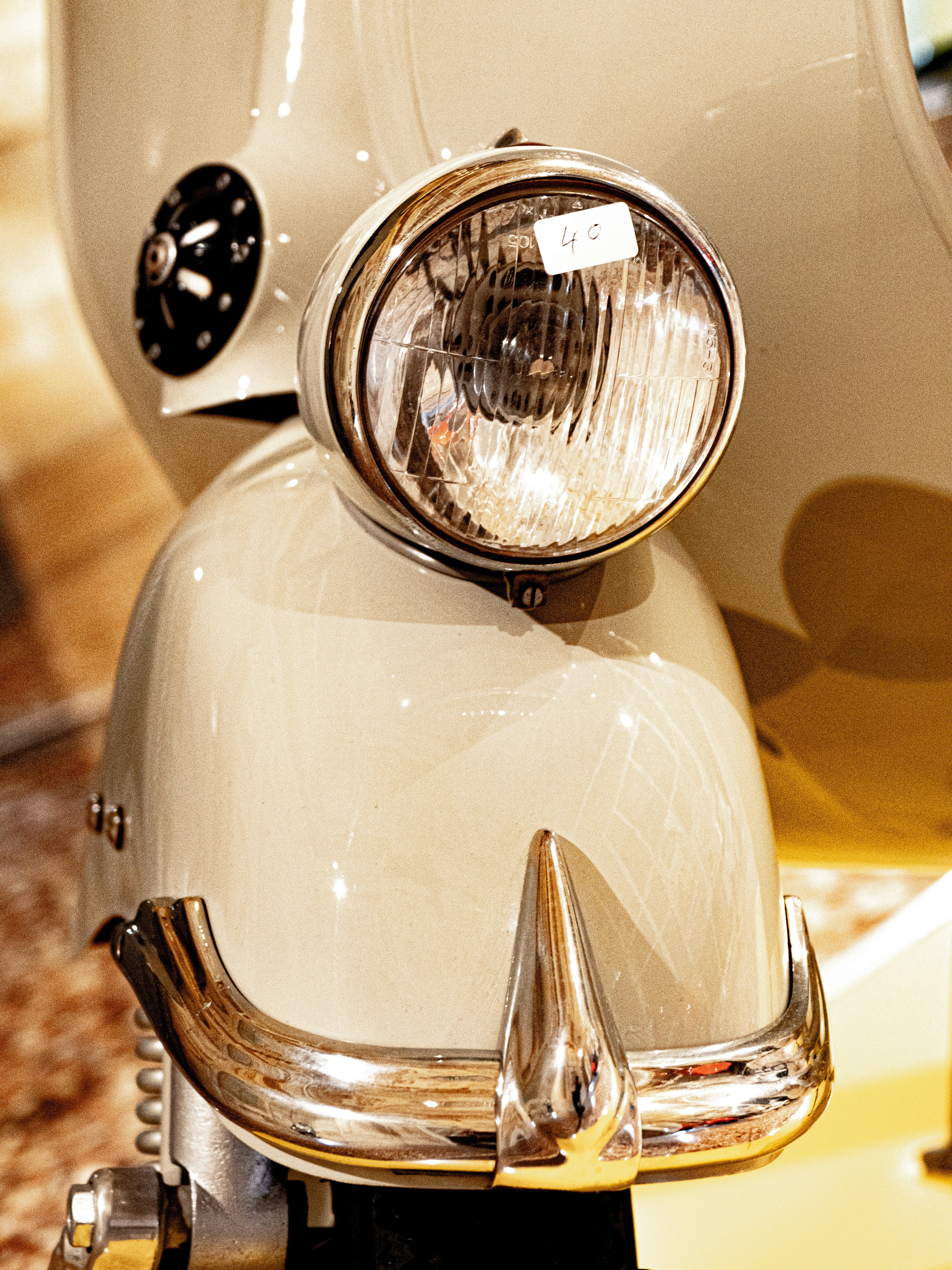 Amber-tinted Headlamp: Close-up of a Vintage Scooter's Front