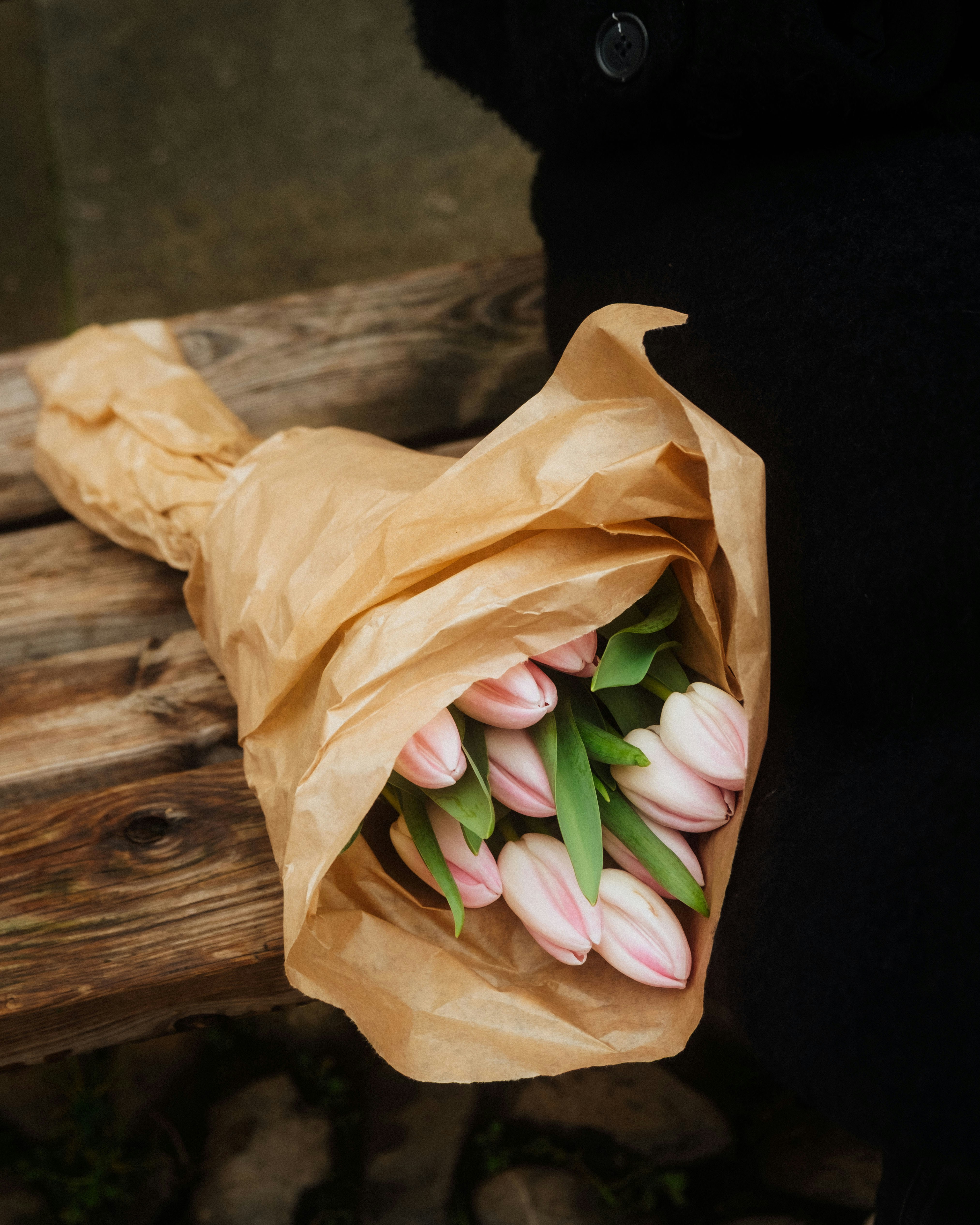 A bouquet of tulips wrapped in brown paper. photo – Free Flowers Image ...