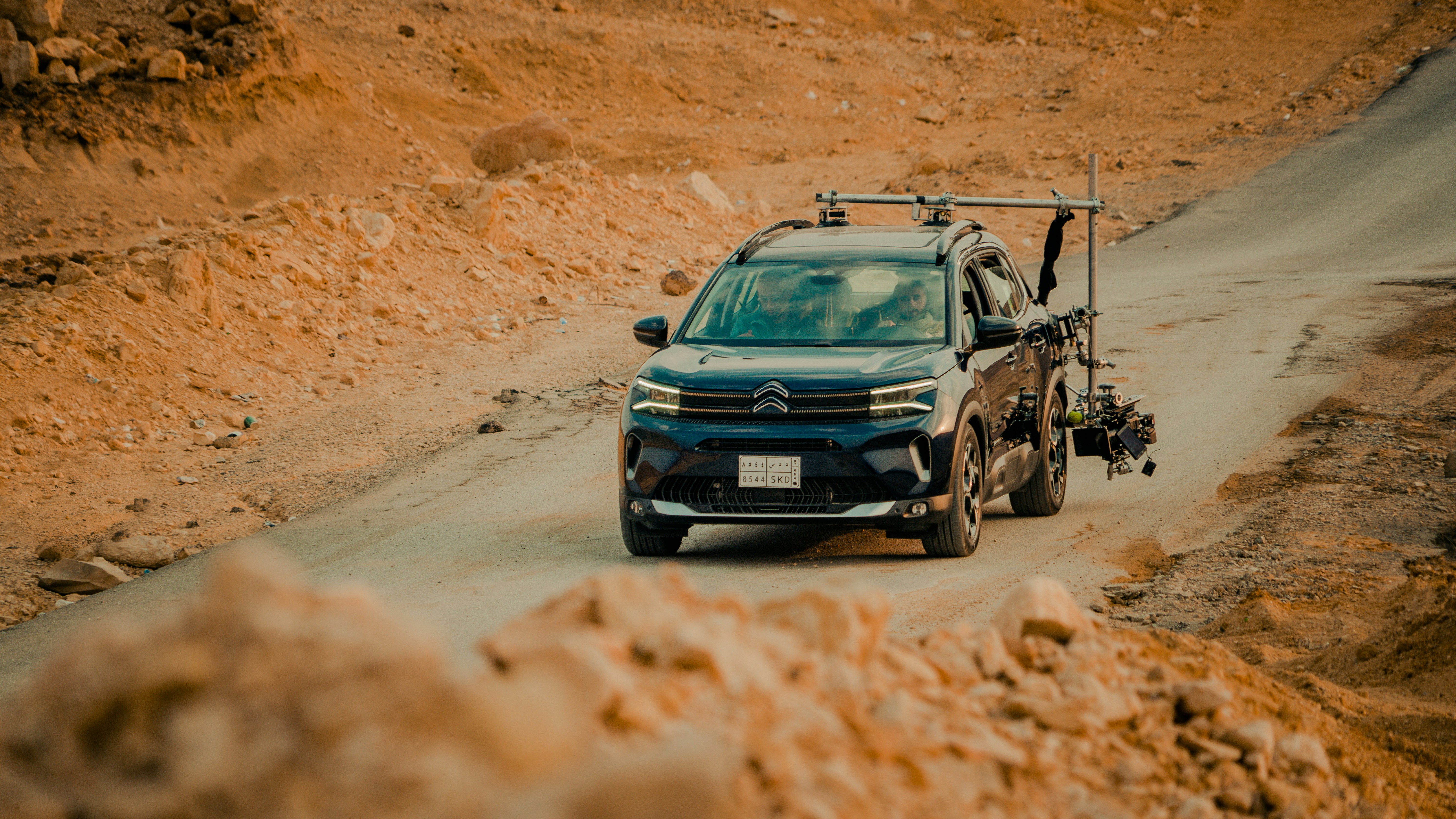 Rugged Trek: A Compact Pickup Navigates a Dusty Canyon Road