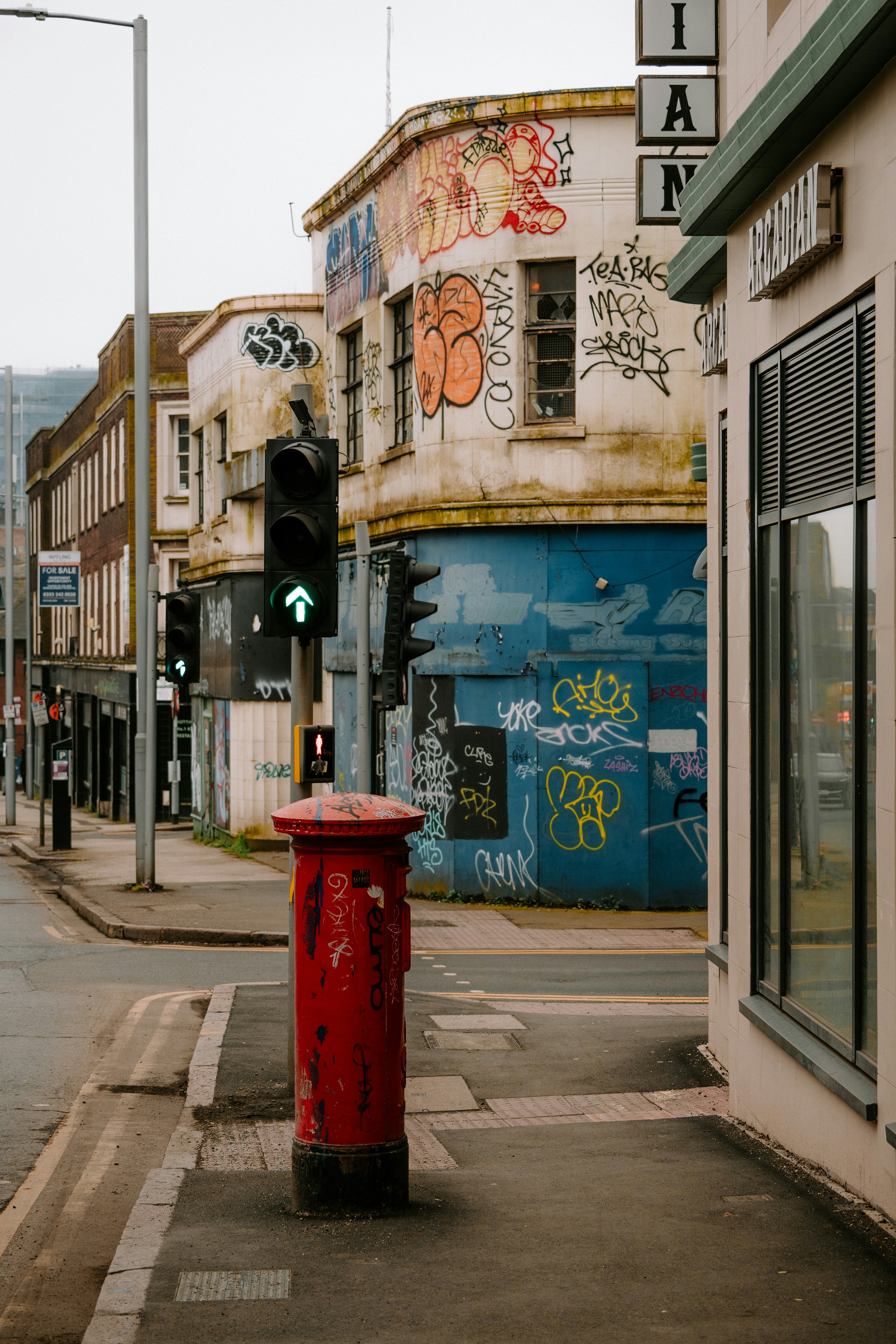 Crimson Sentinel on a Graffiti-Washed Street