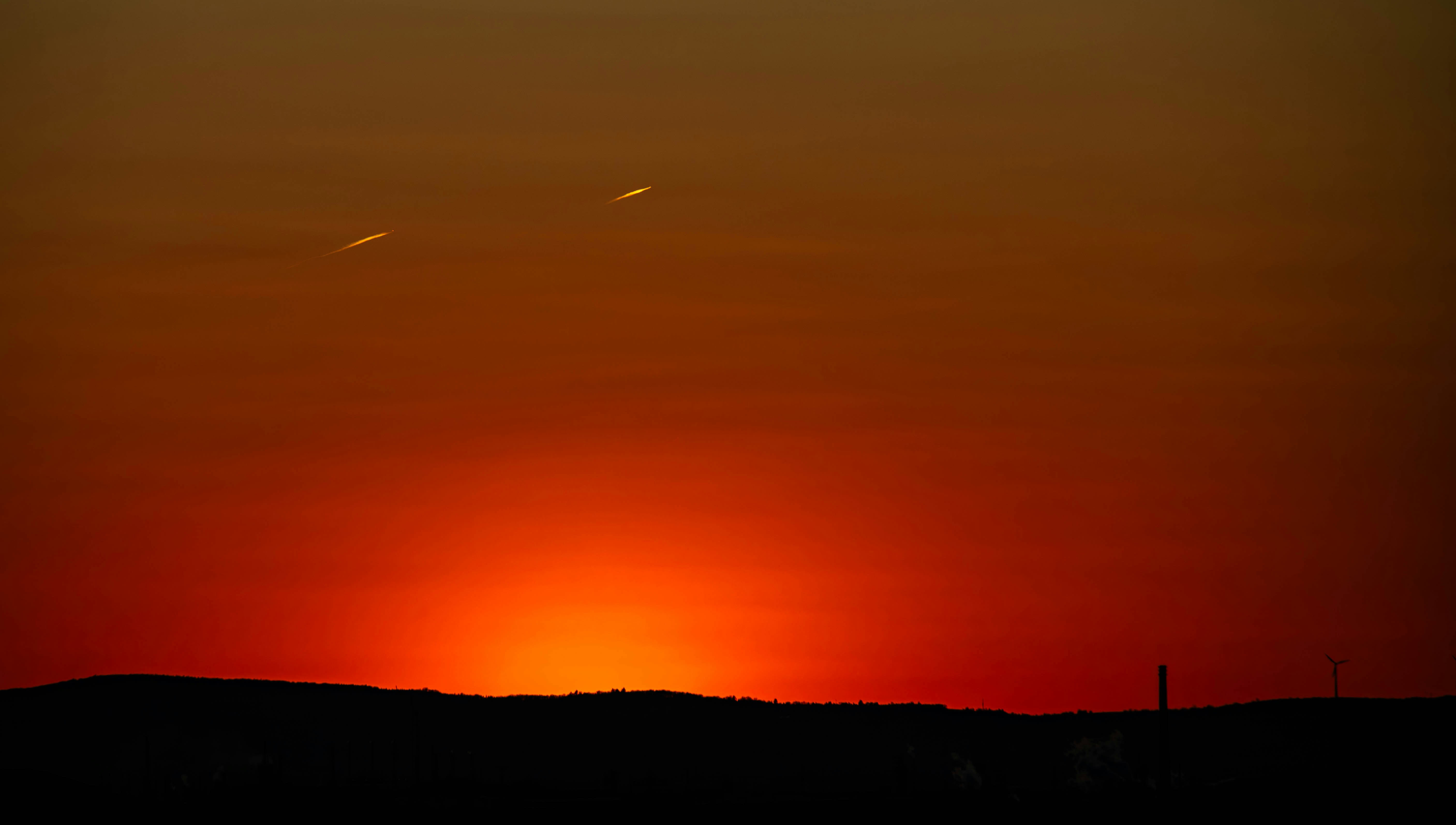 Emberdusk Over a Quiet Horizon: Twin Contrails Etch the Dusk