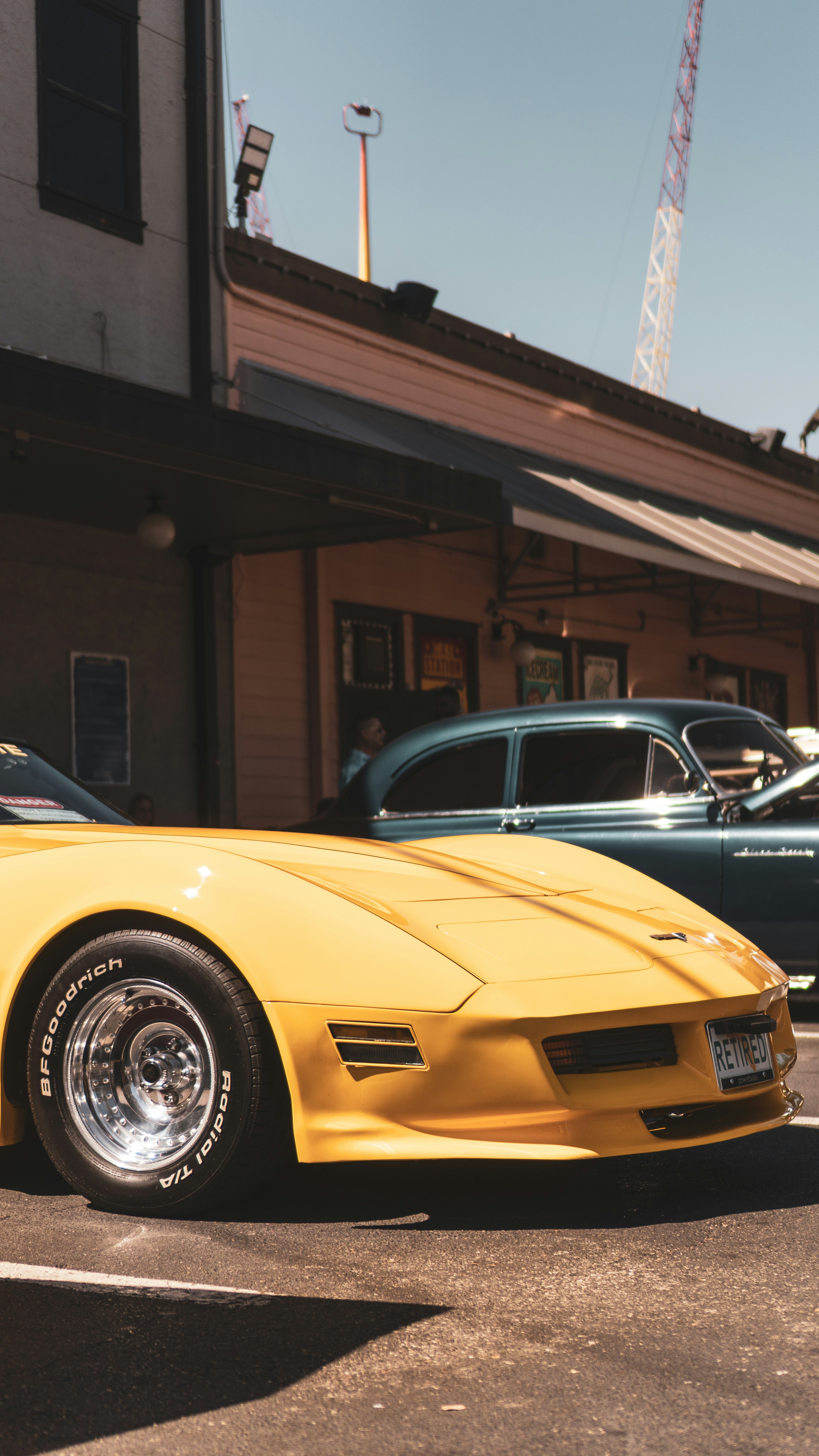 Sunlit Yellow Corvette Framed by a Classic Street Scene