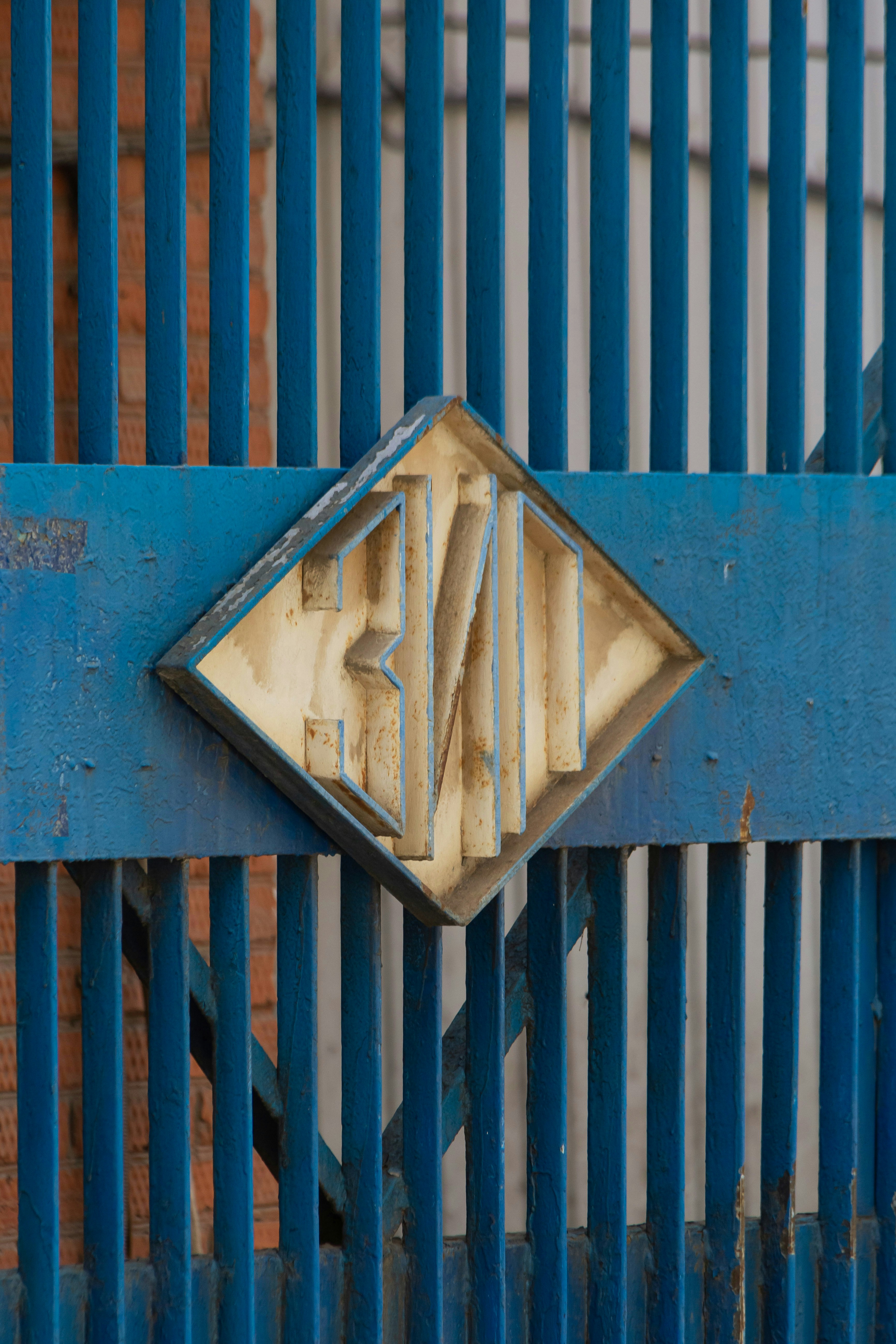 Diagonal Diamond Crest on a Weathered Blue Gate