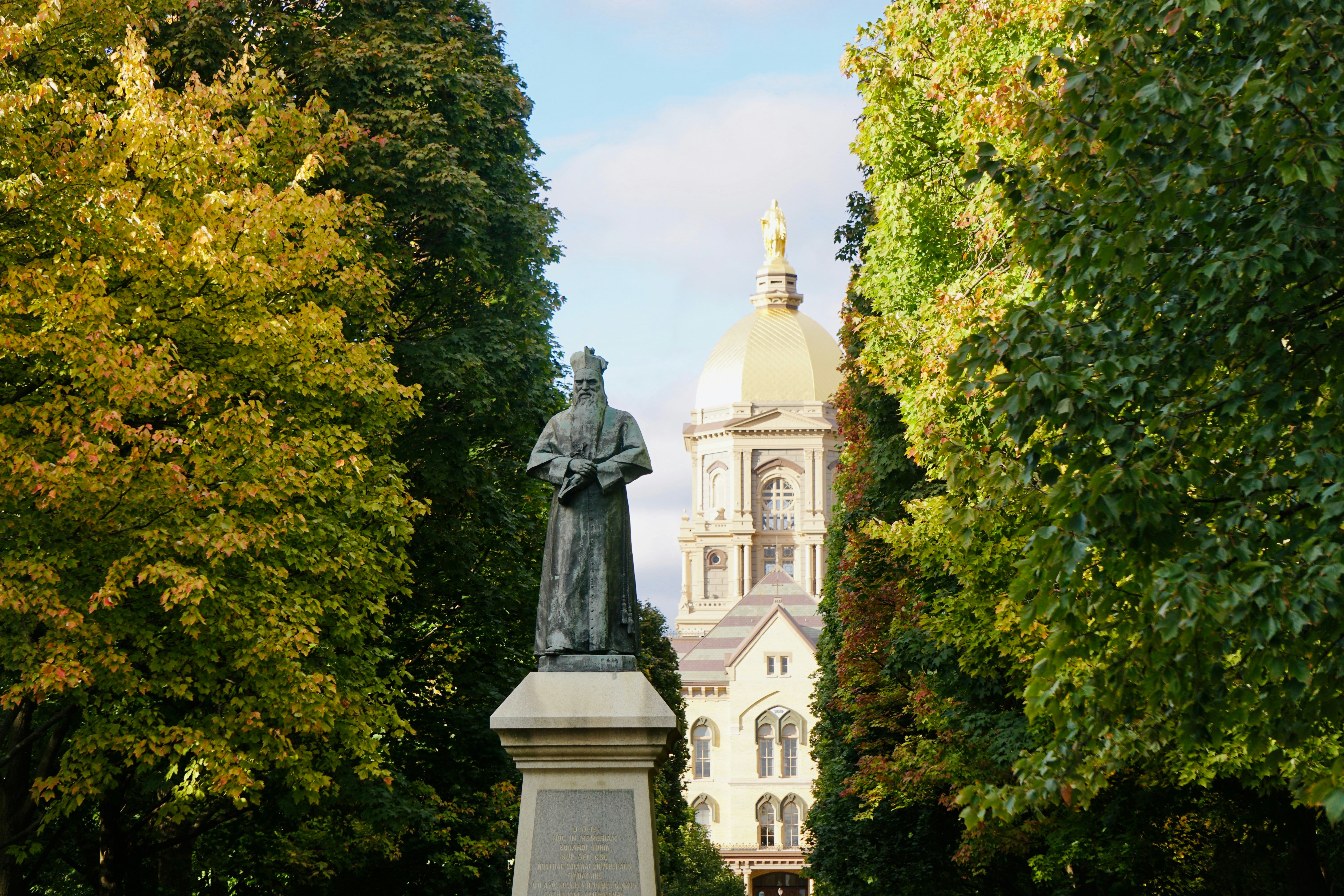 A statue of a saint stands before a building. photo – Free Art Image on ...
