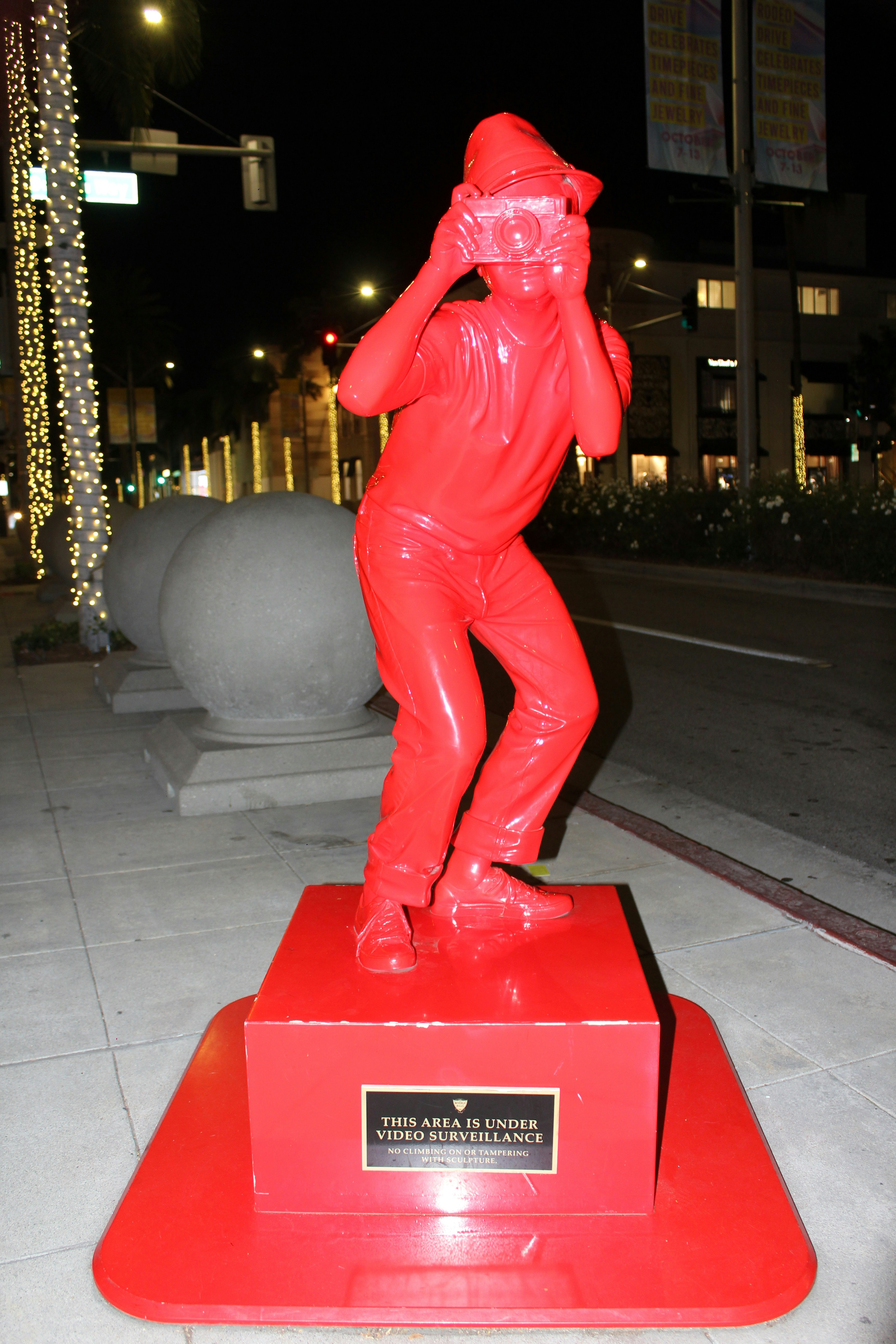 A red statue of a photographer stands in a city. photo – Free Art Image ...