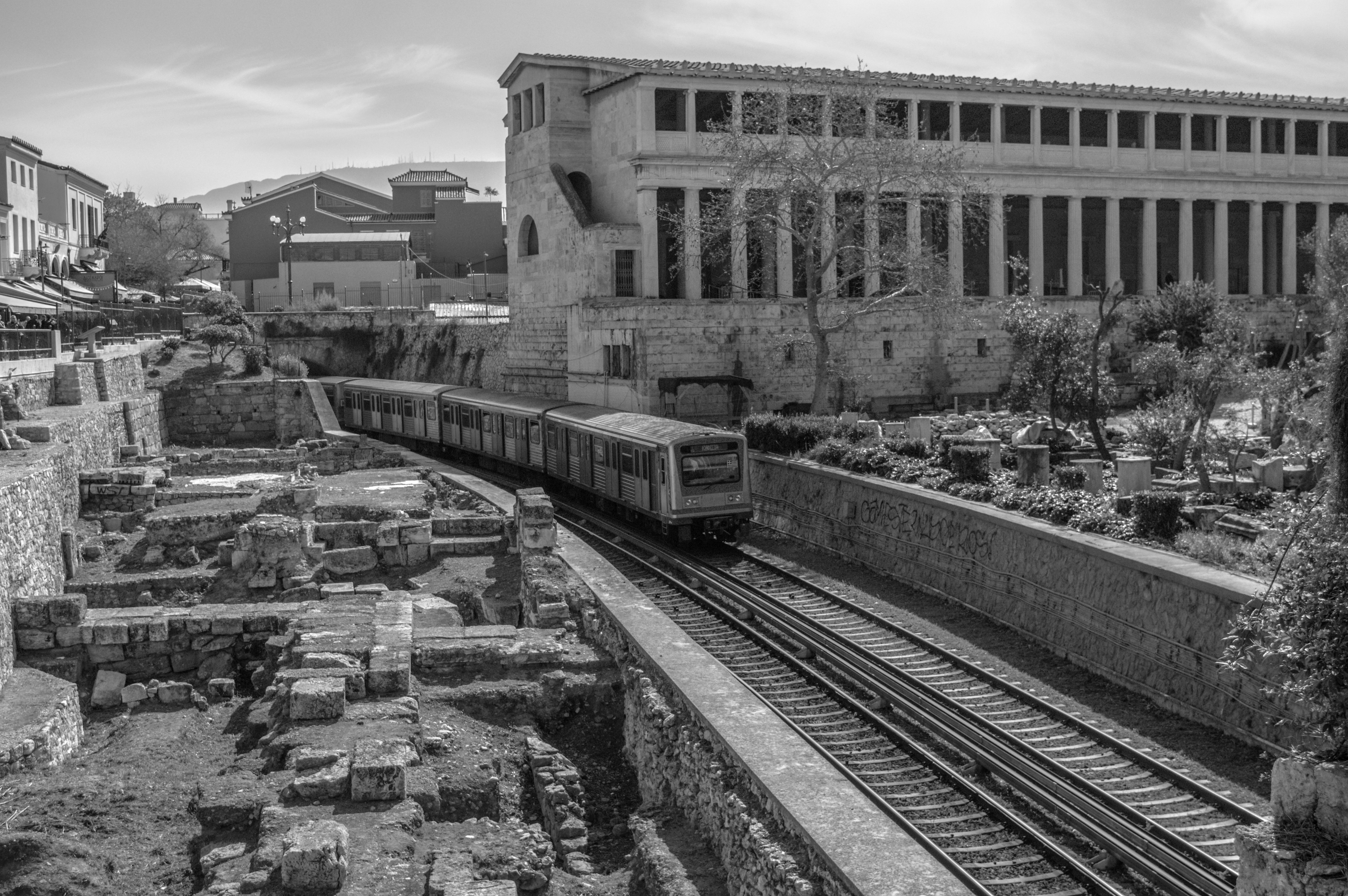A train tracks past ancient ruins in athens. photo – Free Car Image on ...