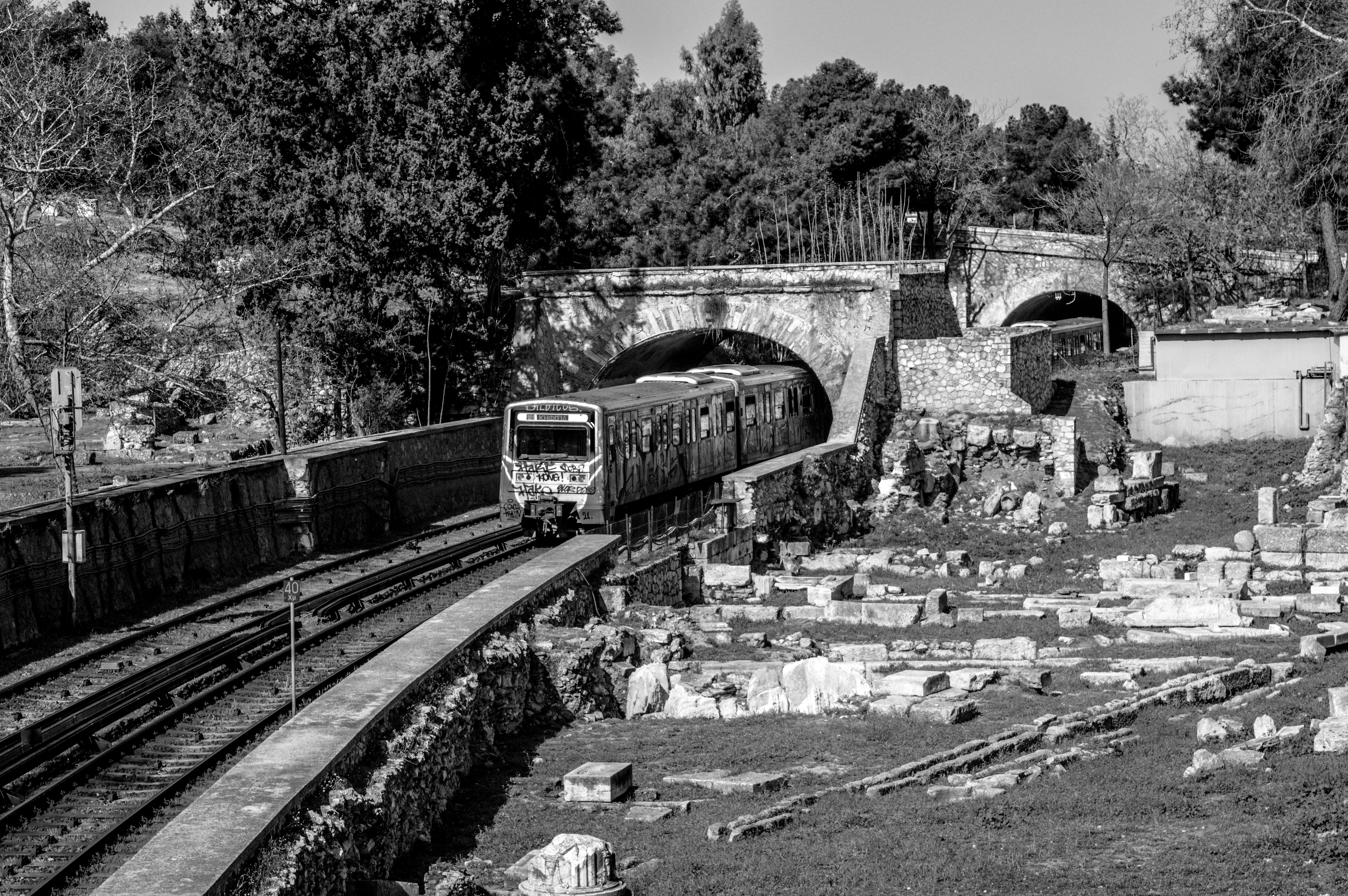 A train emerges from a tunnel near ruins. photo – Free Human Image on ...