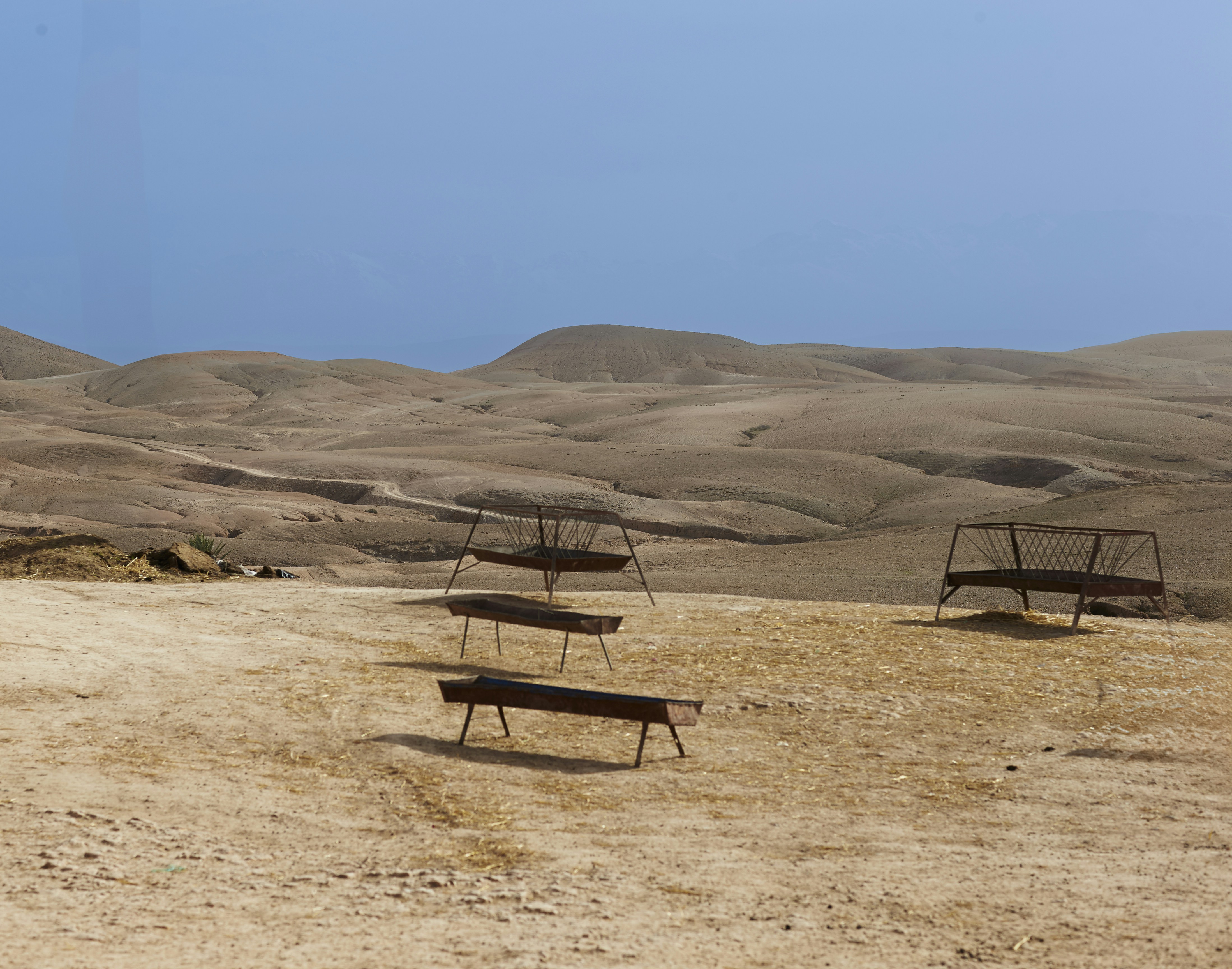 Desert benches under a cobalt sky: echoes of stillness