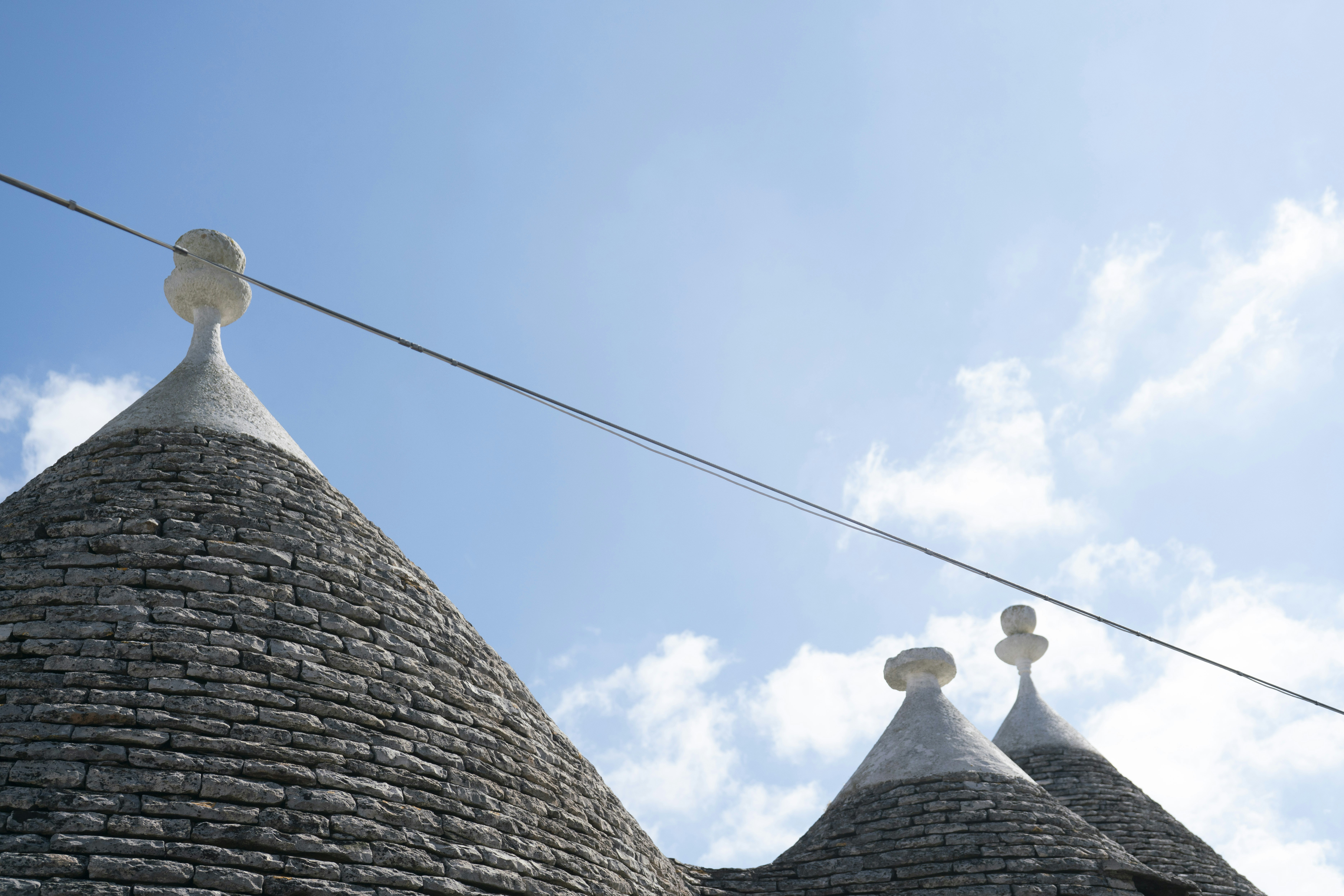 Cone-shaped roofs with distinctive tops are pictured. photo – Free ...