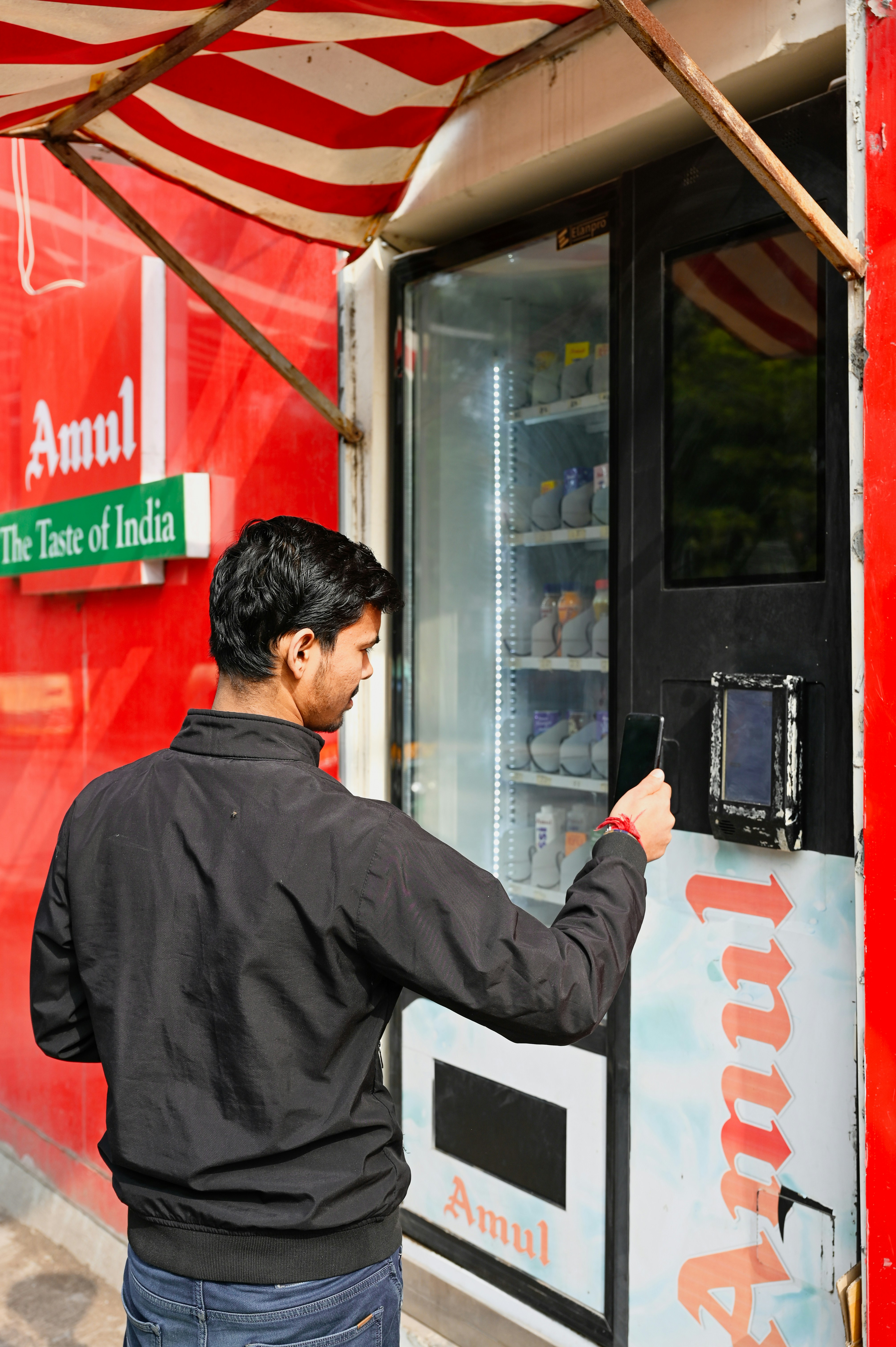 Swipe and Sip at the Red Amul Stand: A Street Moment