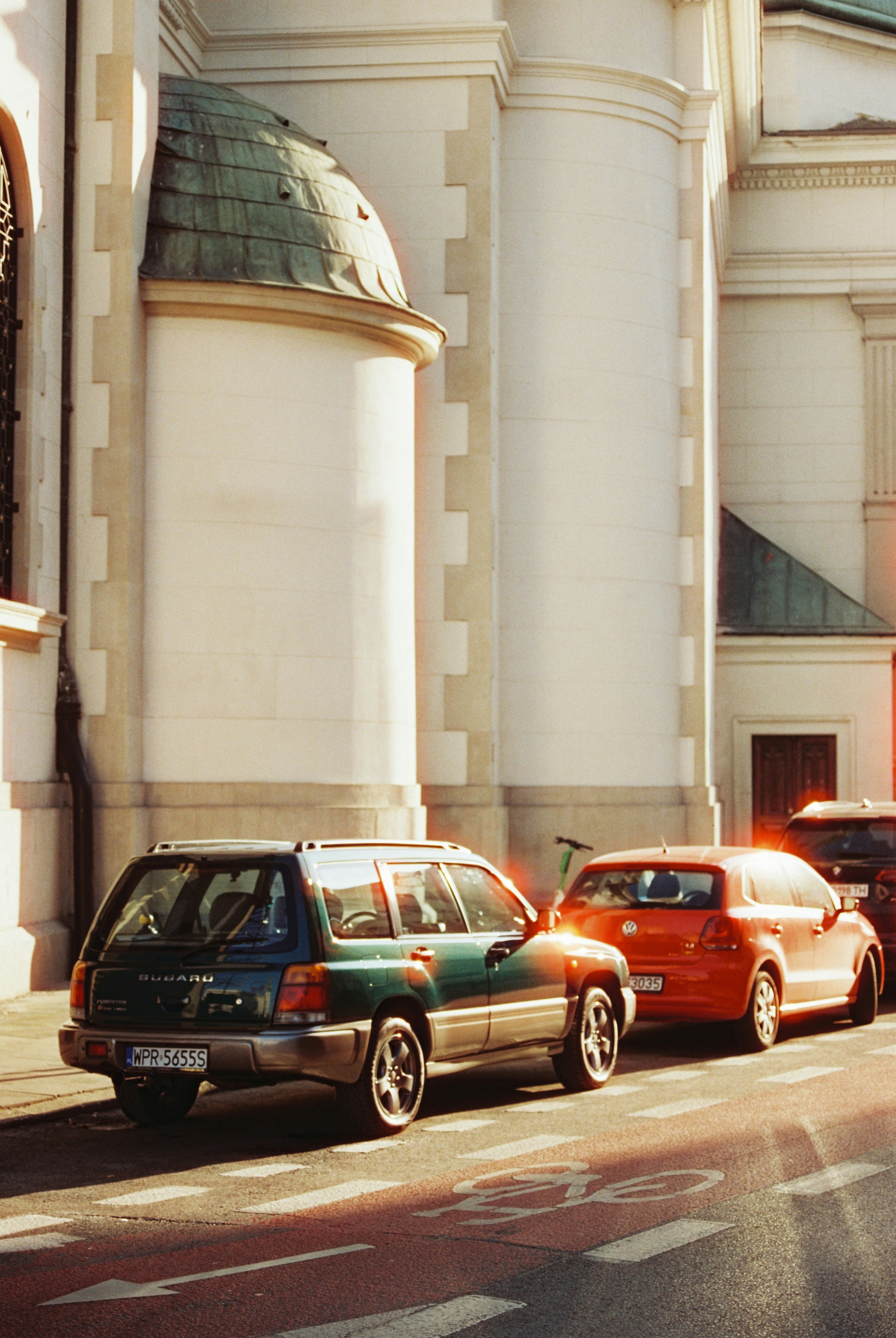 City Street Echoes: Cars in Line beneath Classical Facades
