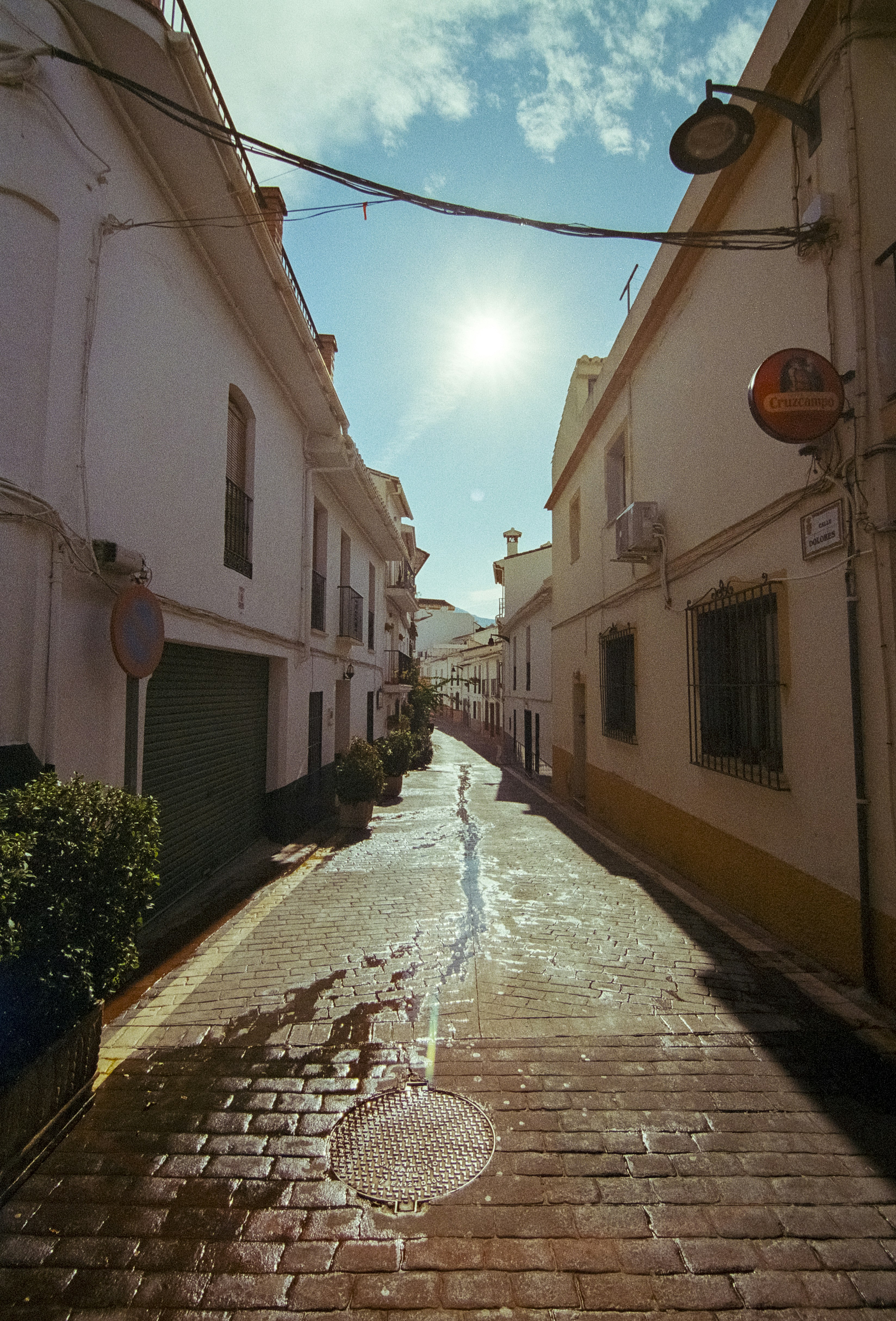 A narrow street in a sunny, european town.