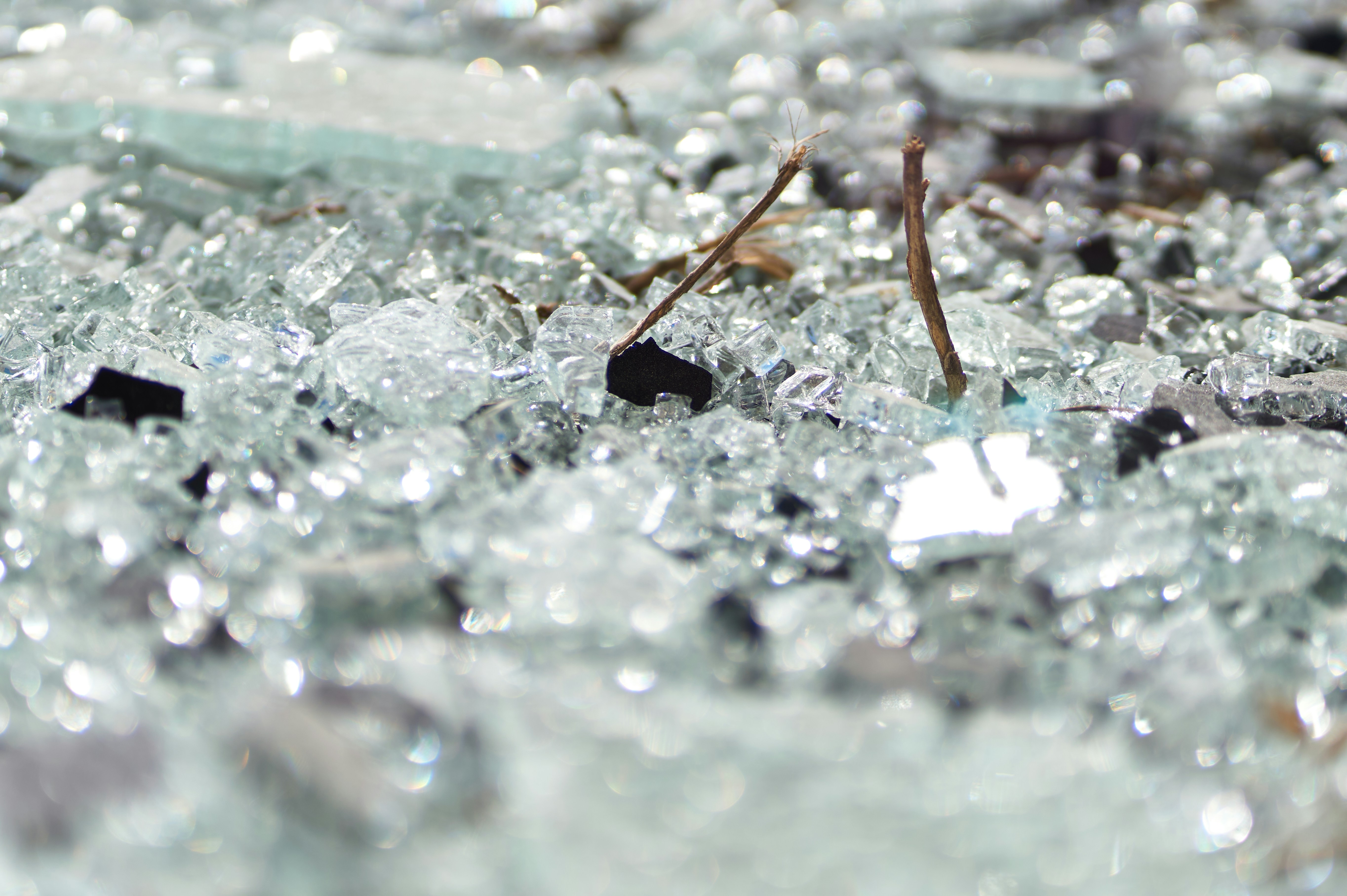 Broken glass shards are scattered on a surface. photo – Free Jewelry ...