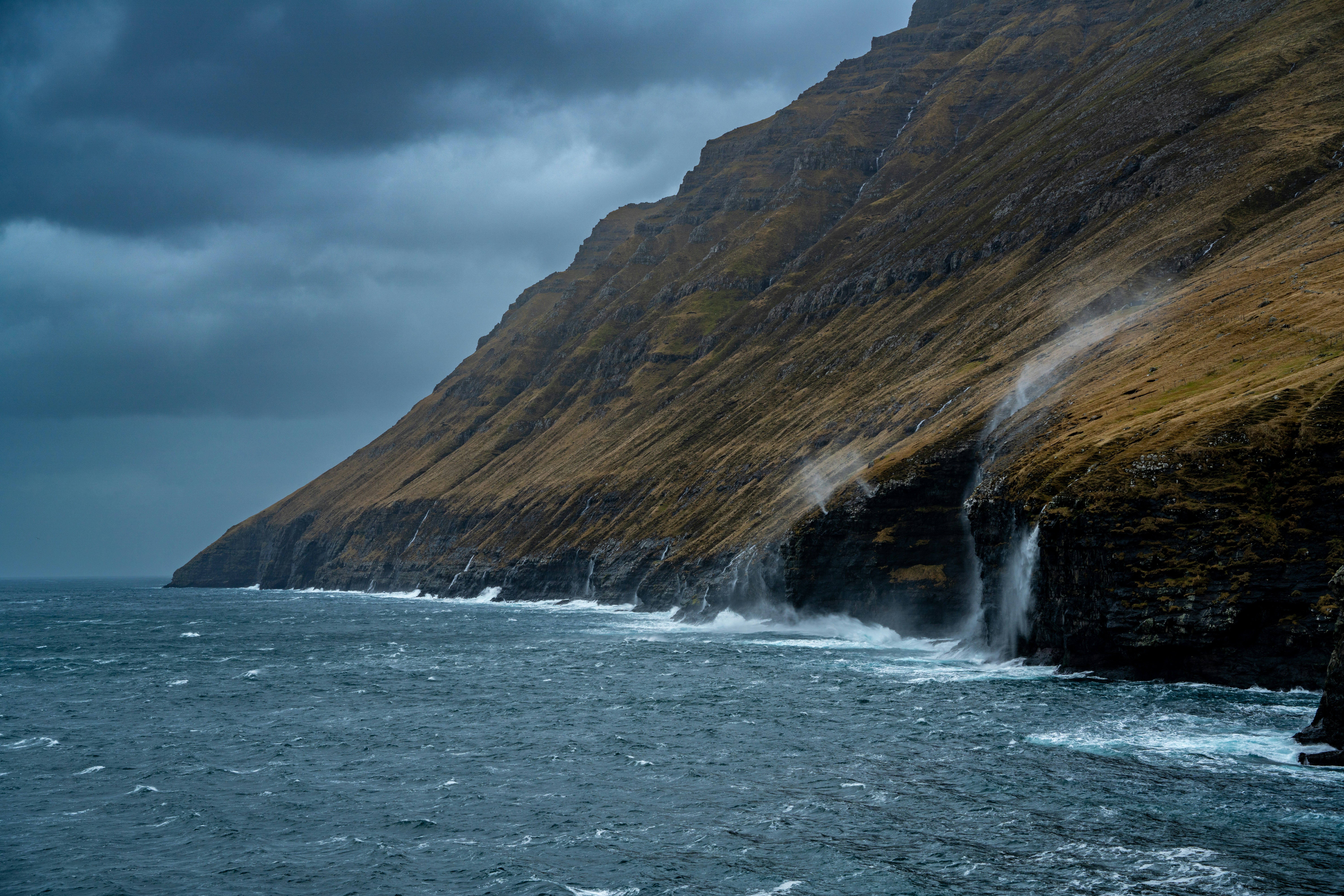 Coastal cliffs with waterfalls crashing into the ocean. photo – Free ...