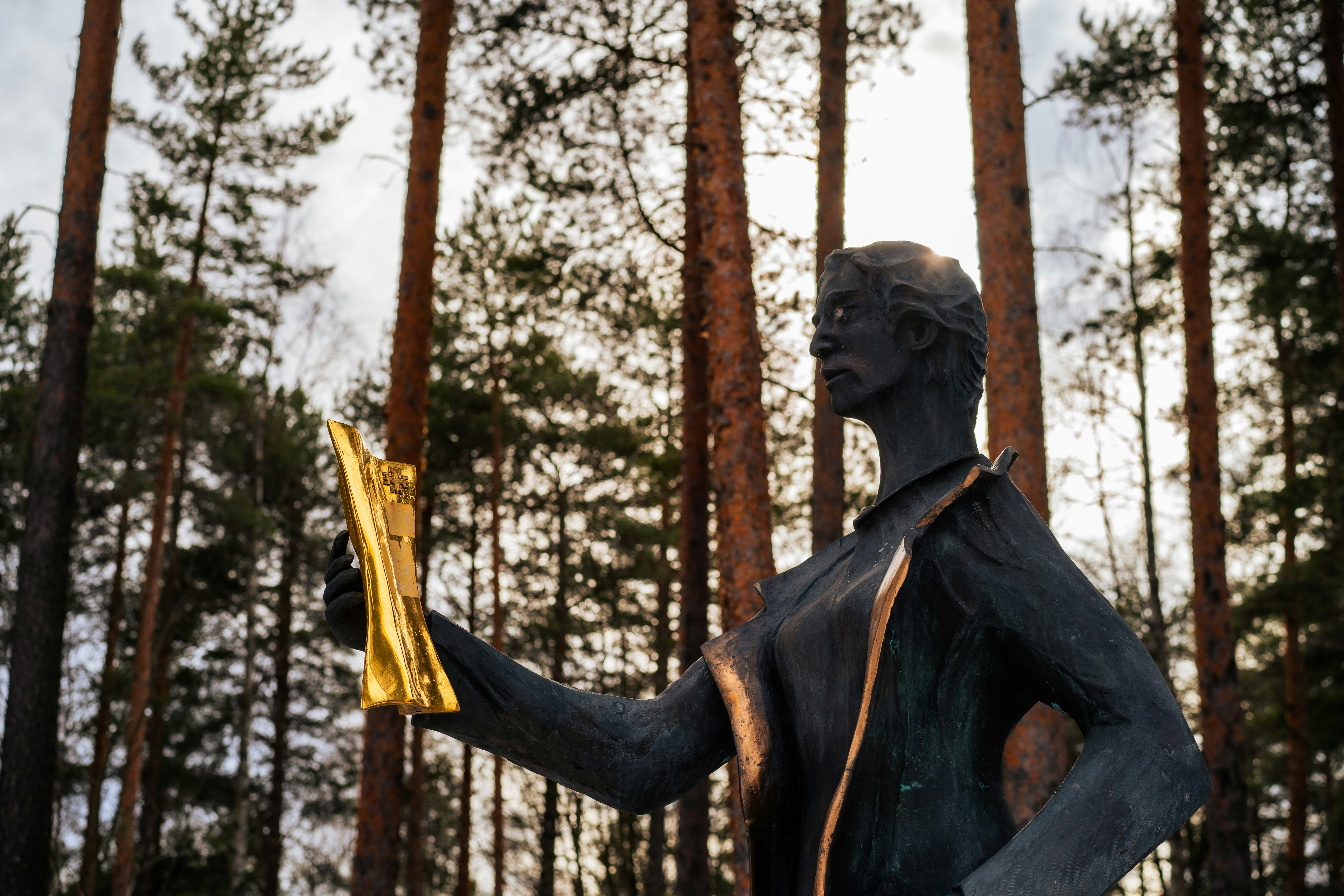 A statue reads a golden scroll outdoors. photo – Free Forest Image on ...