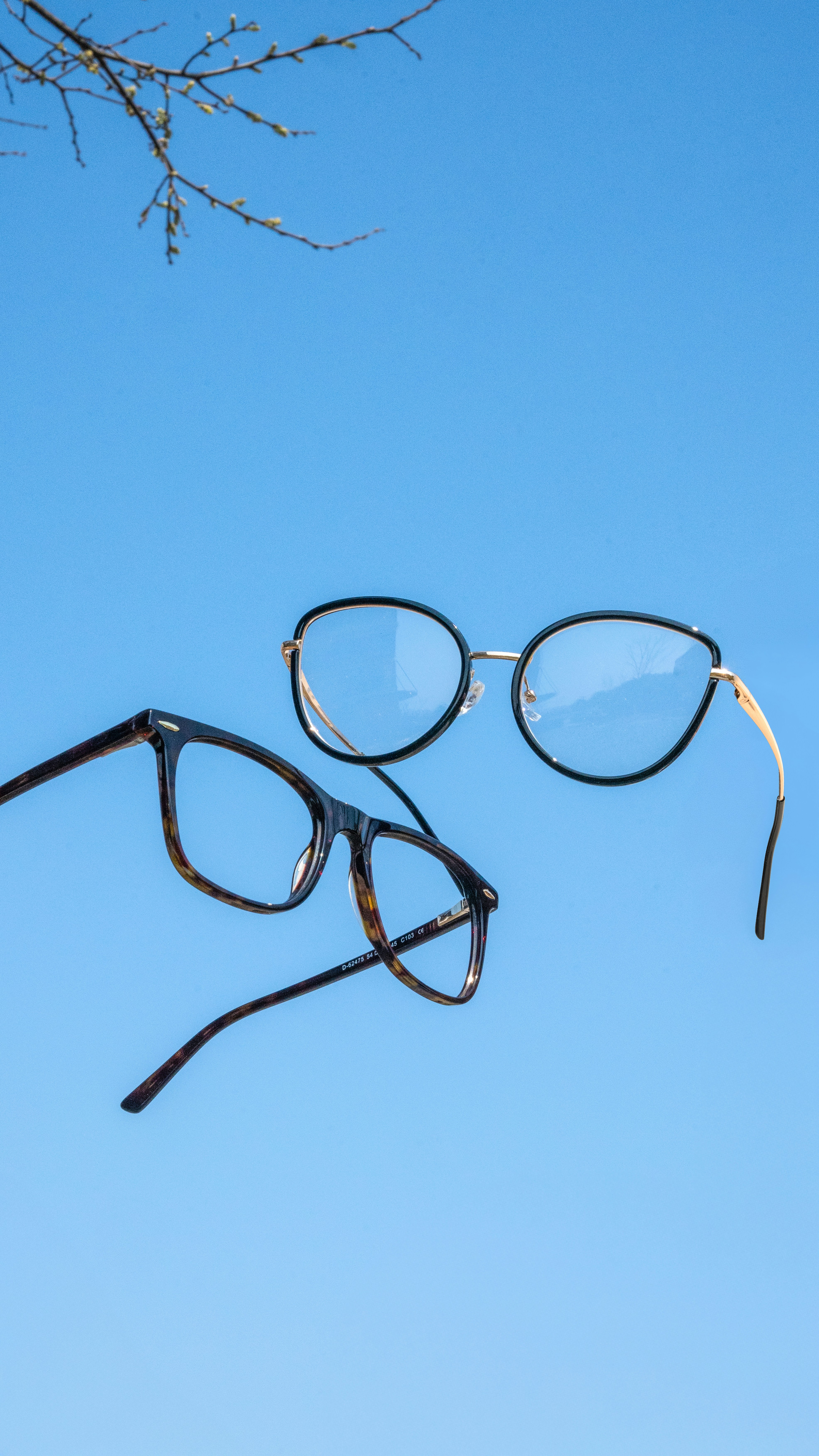 Two pairs of glasses are suspended in the sky. photo – Free Glasses ...