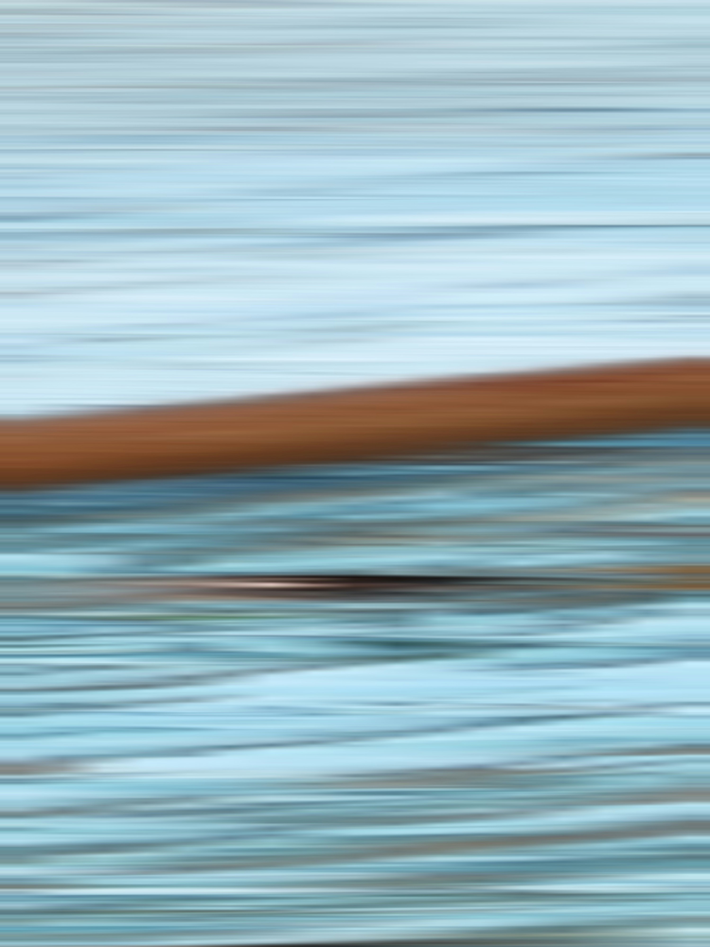 Abstract representation of flowing water with blurred lines of brown and blue, suggesting movement and tranquility.