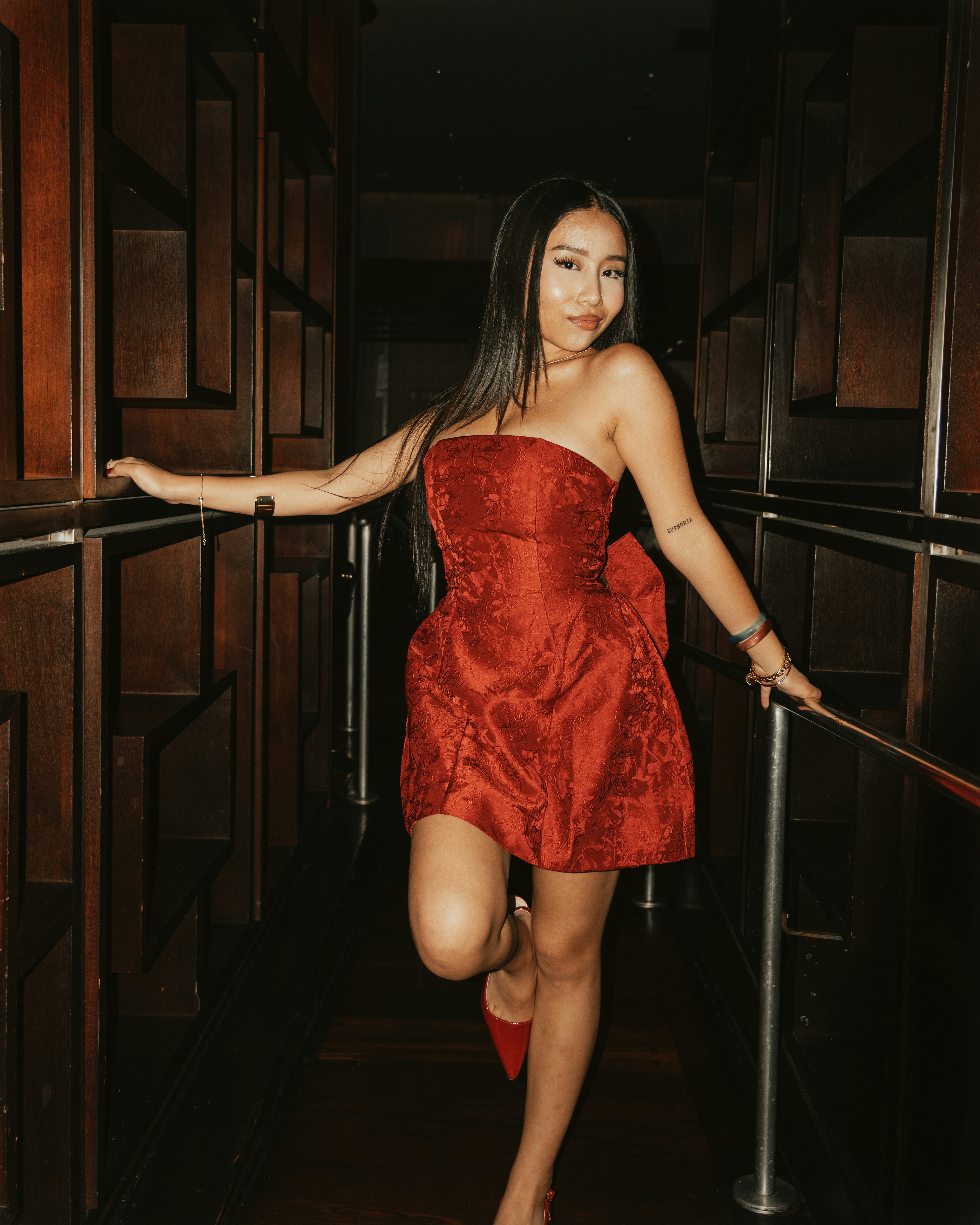 A woman in a red dress poses fashionably. photo – Free Woman Image on ...