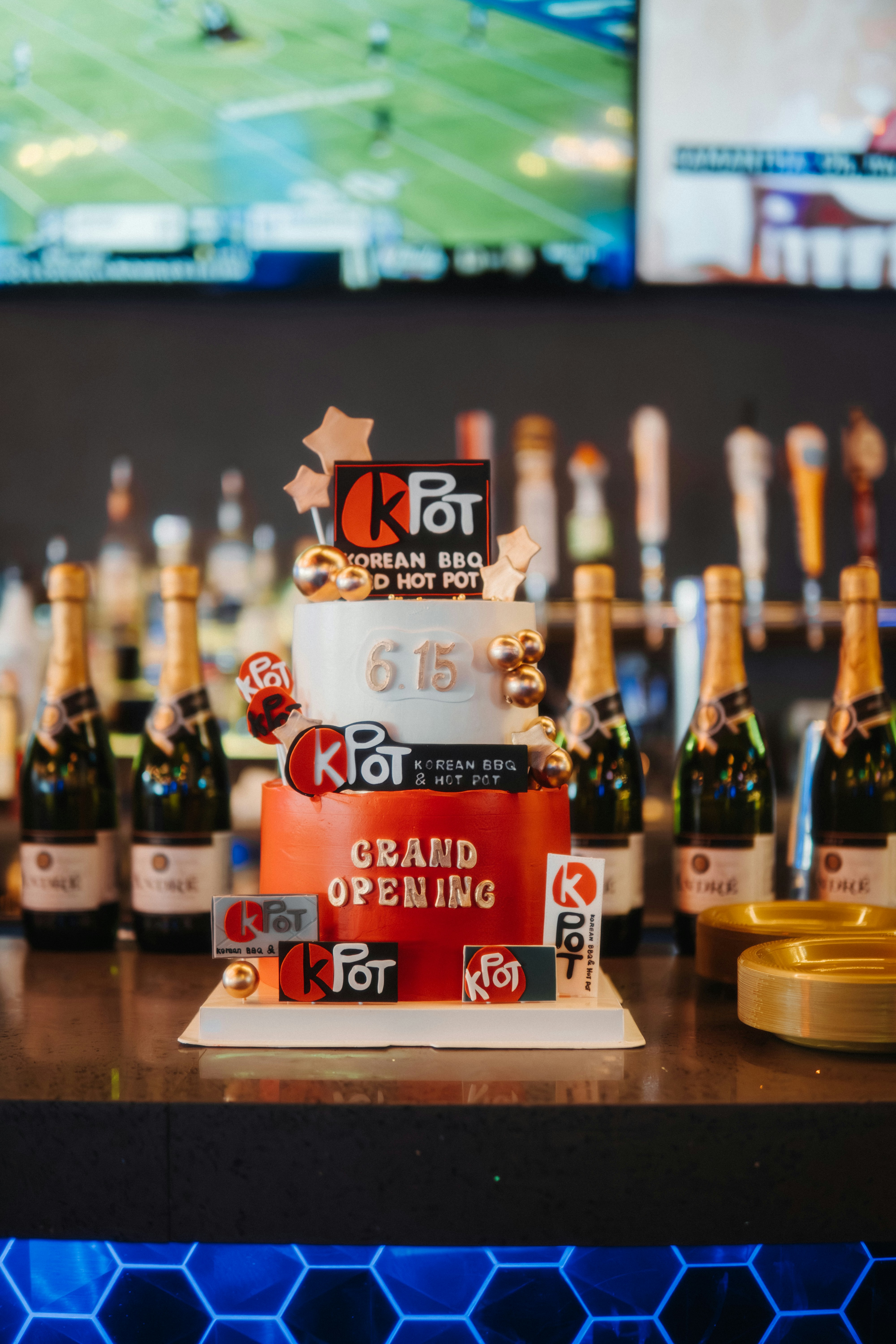 K-Pot Grand Opening Cake with Bottles in the Background