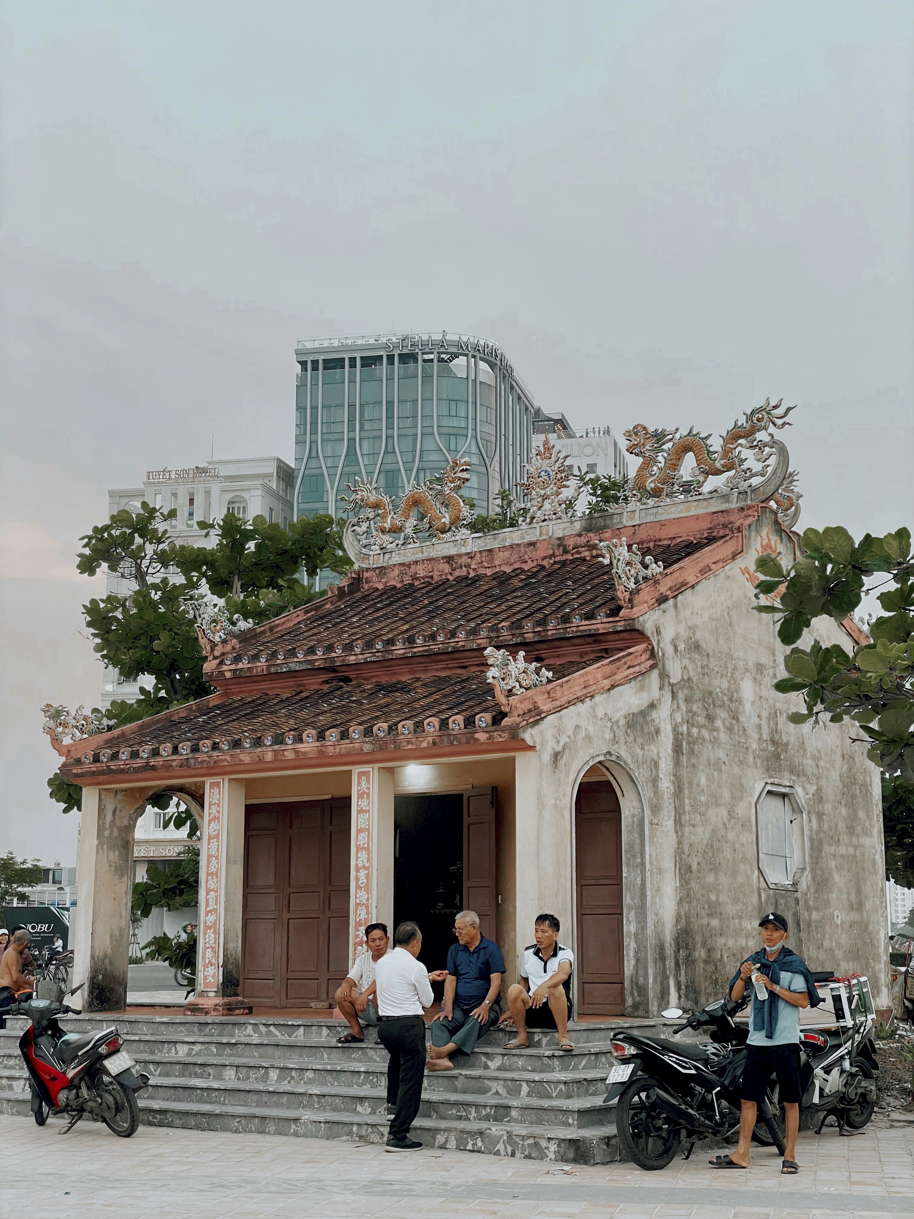 People sit outside a traditional temple. photo – Free Vintage Image on ...