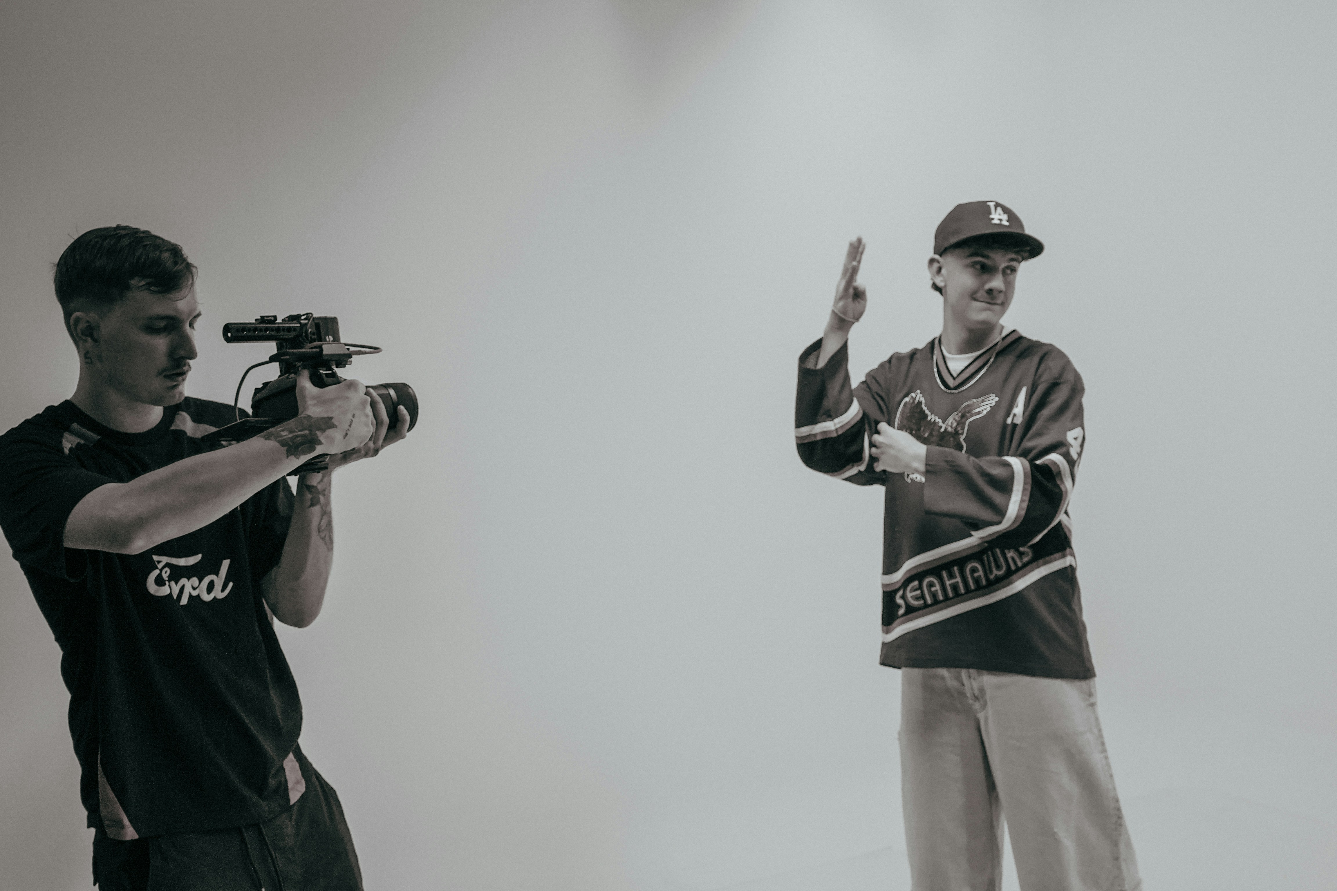 A man films another man posing for camera. photo – Free Man Image on ...