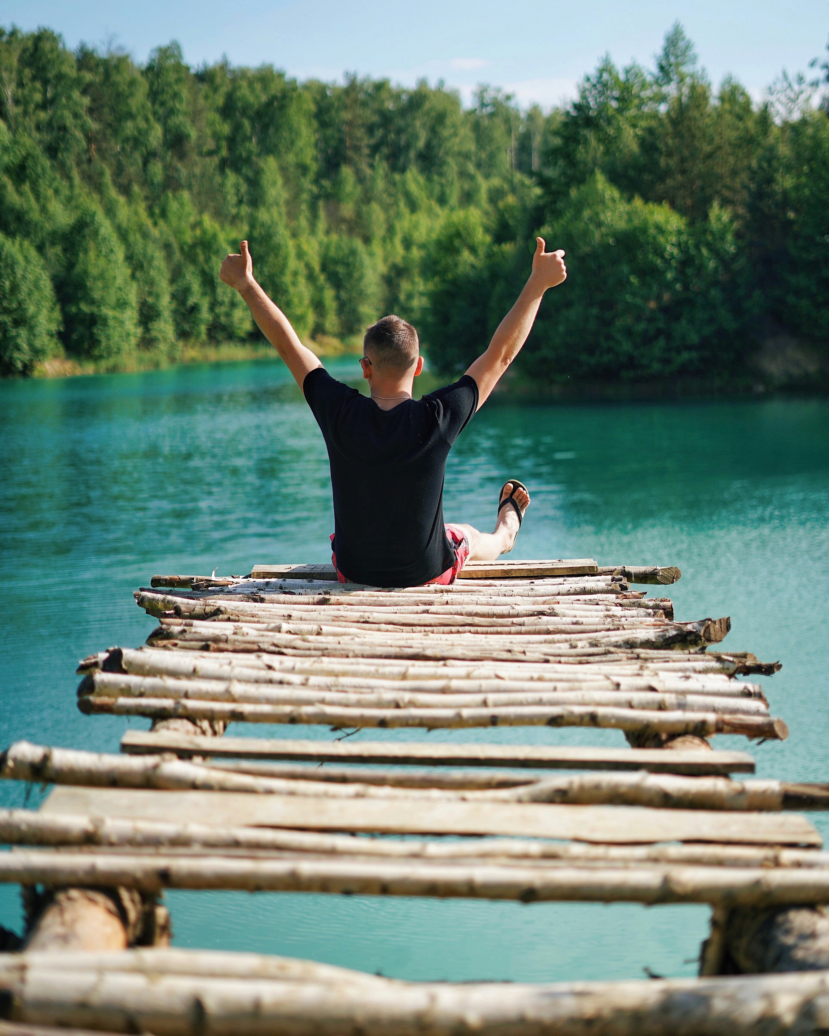 Thumbs Up from the End of a Rustic Pier Over Turquoise Waters
