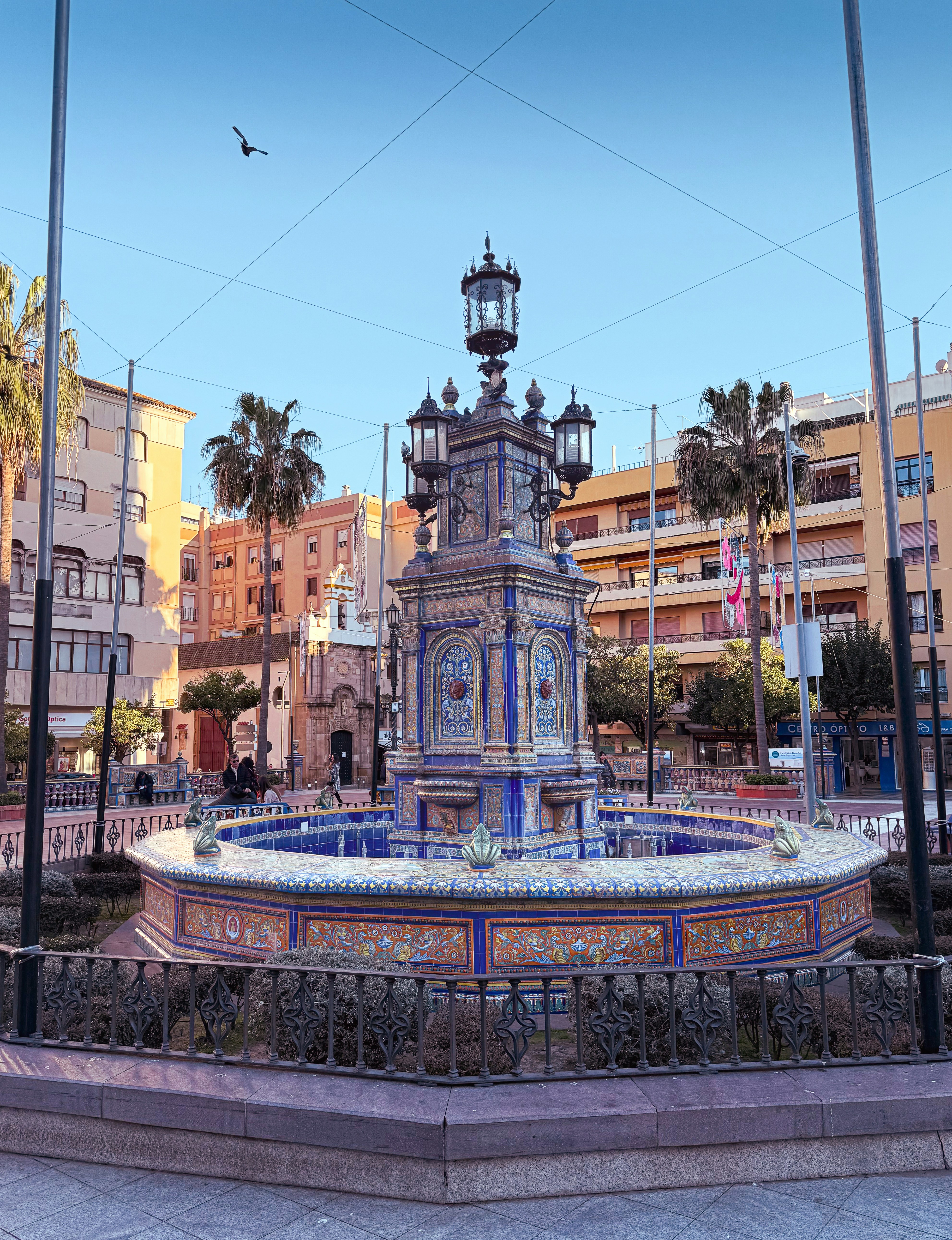 A decorative fountain stands in a city square.