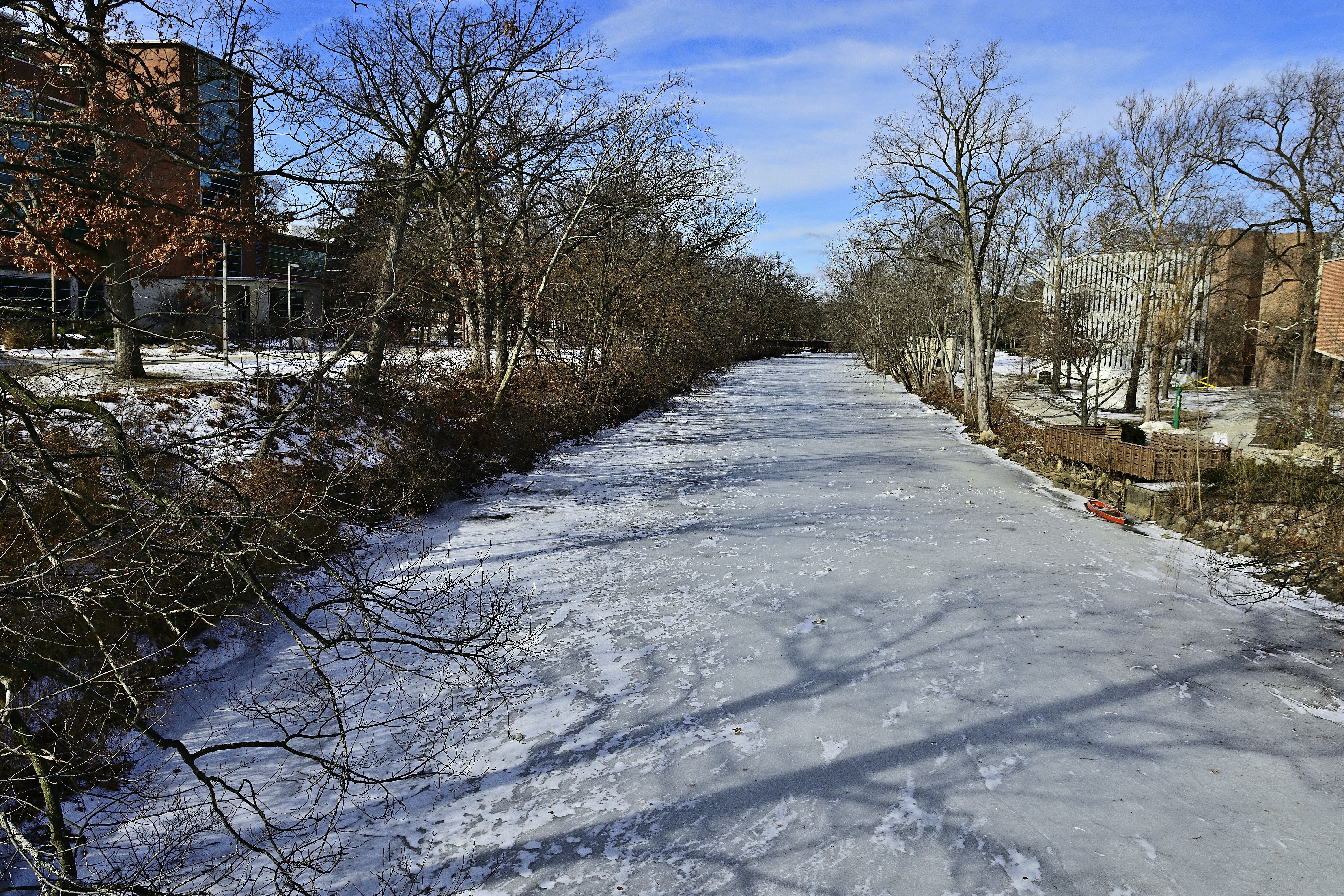 A frozen river flows through the winter landscape. photo – Free Snow ...