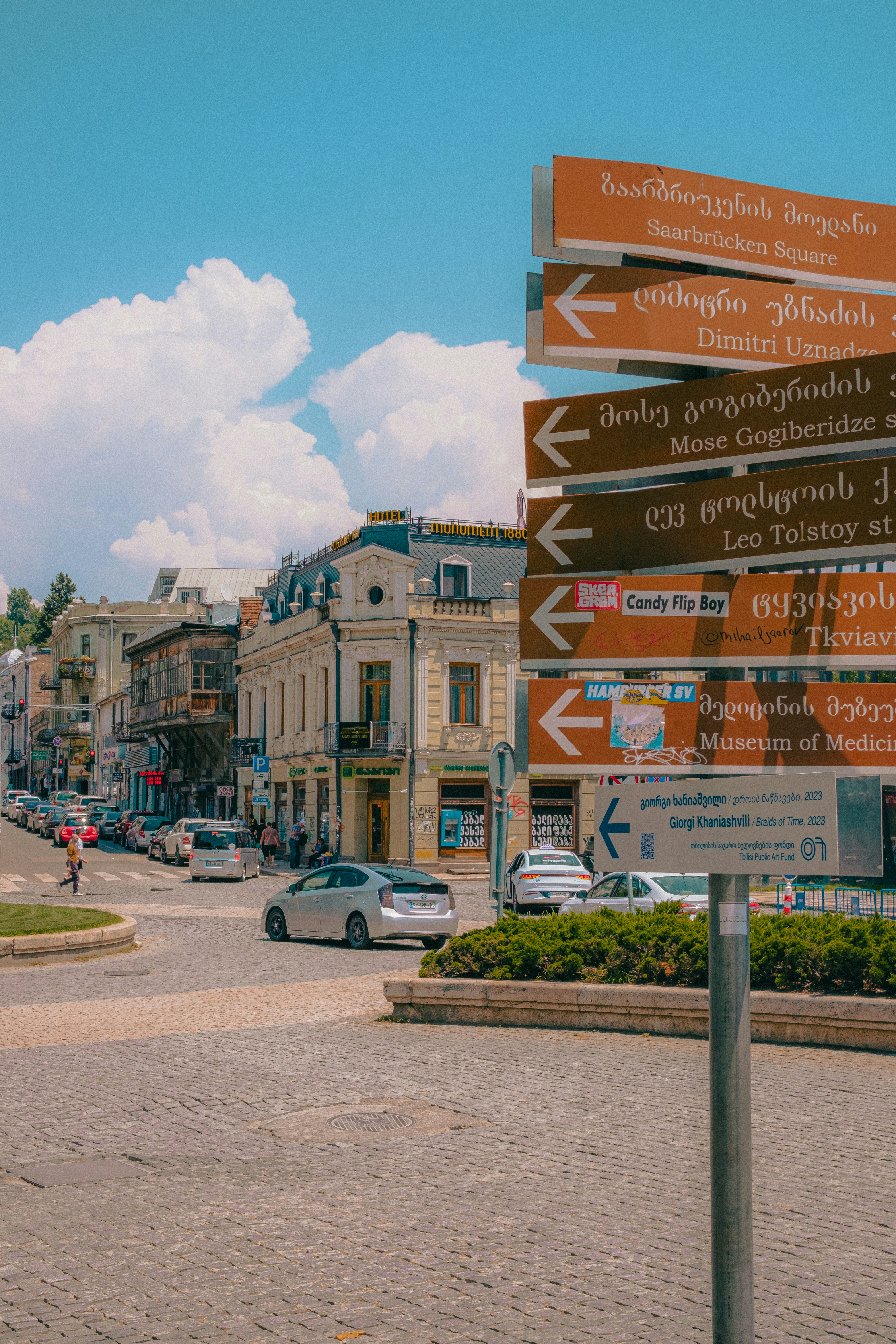 Directional signs point towards various landmarks in a european city ...