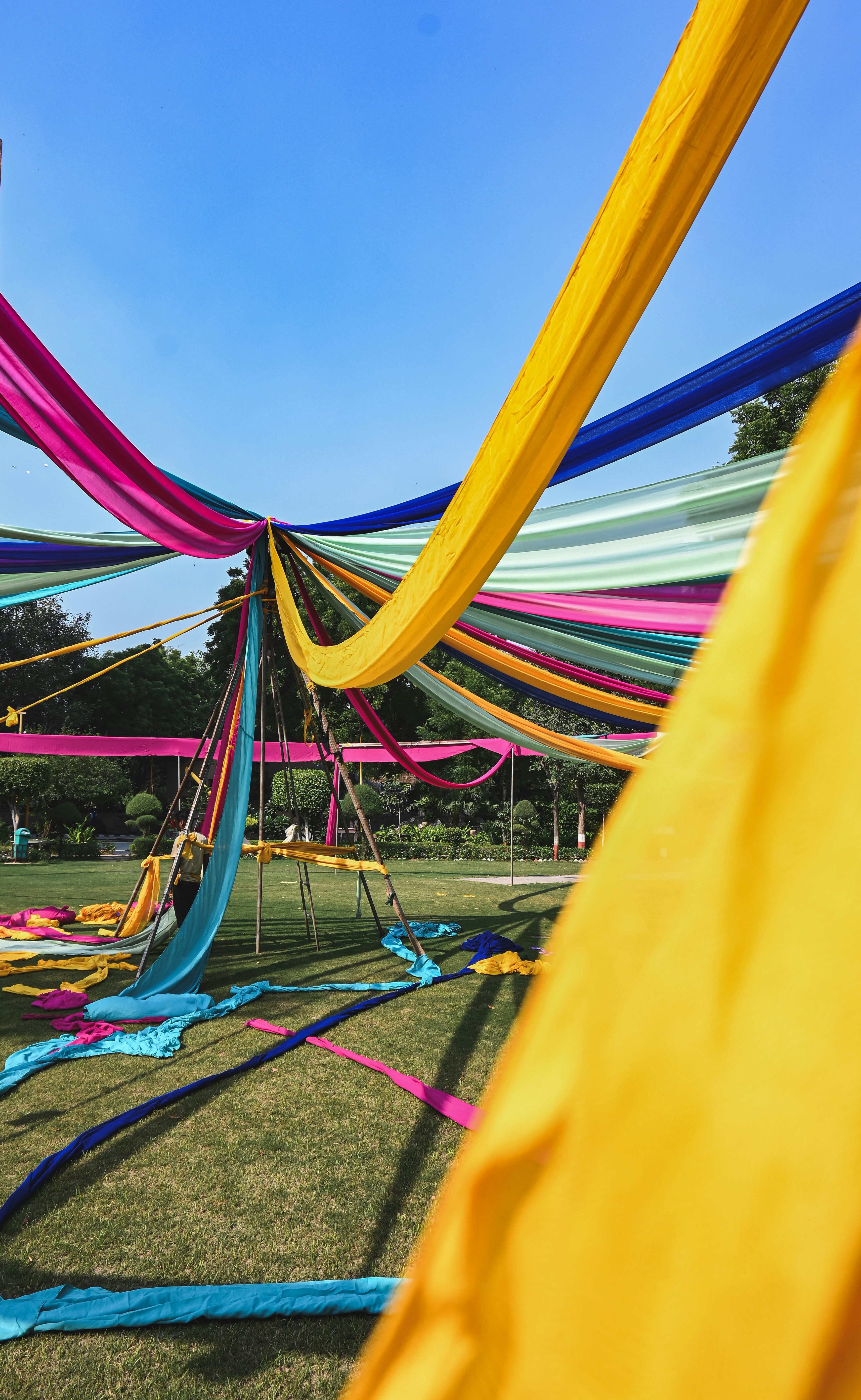 Colorful fabrics decorate a grassy area. photo – Free Girl Image on ...