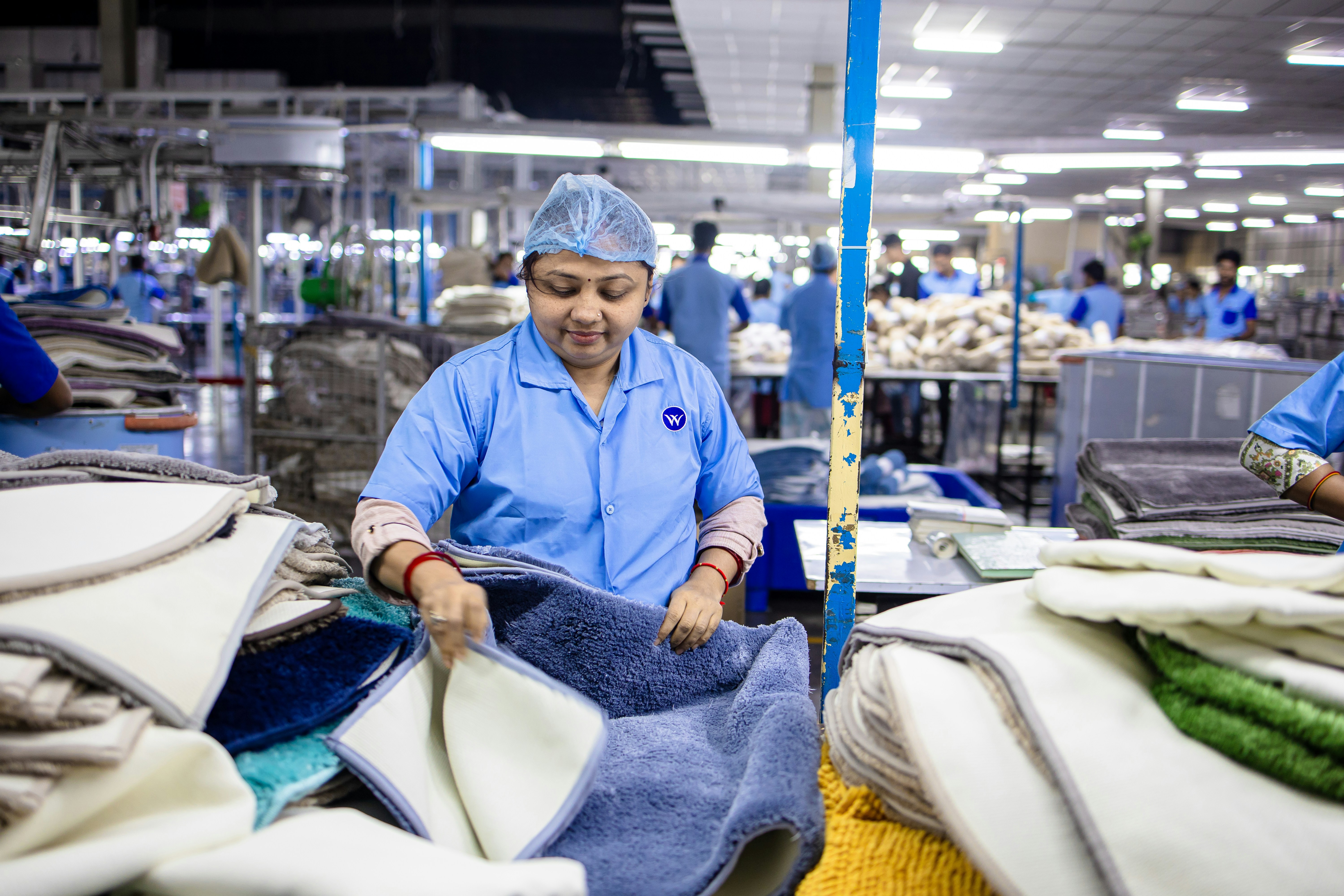 Woman works at a textile factory, sorting products. photo – Free Woman ...