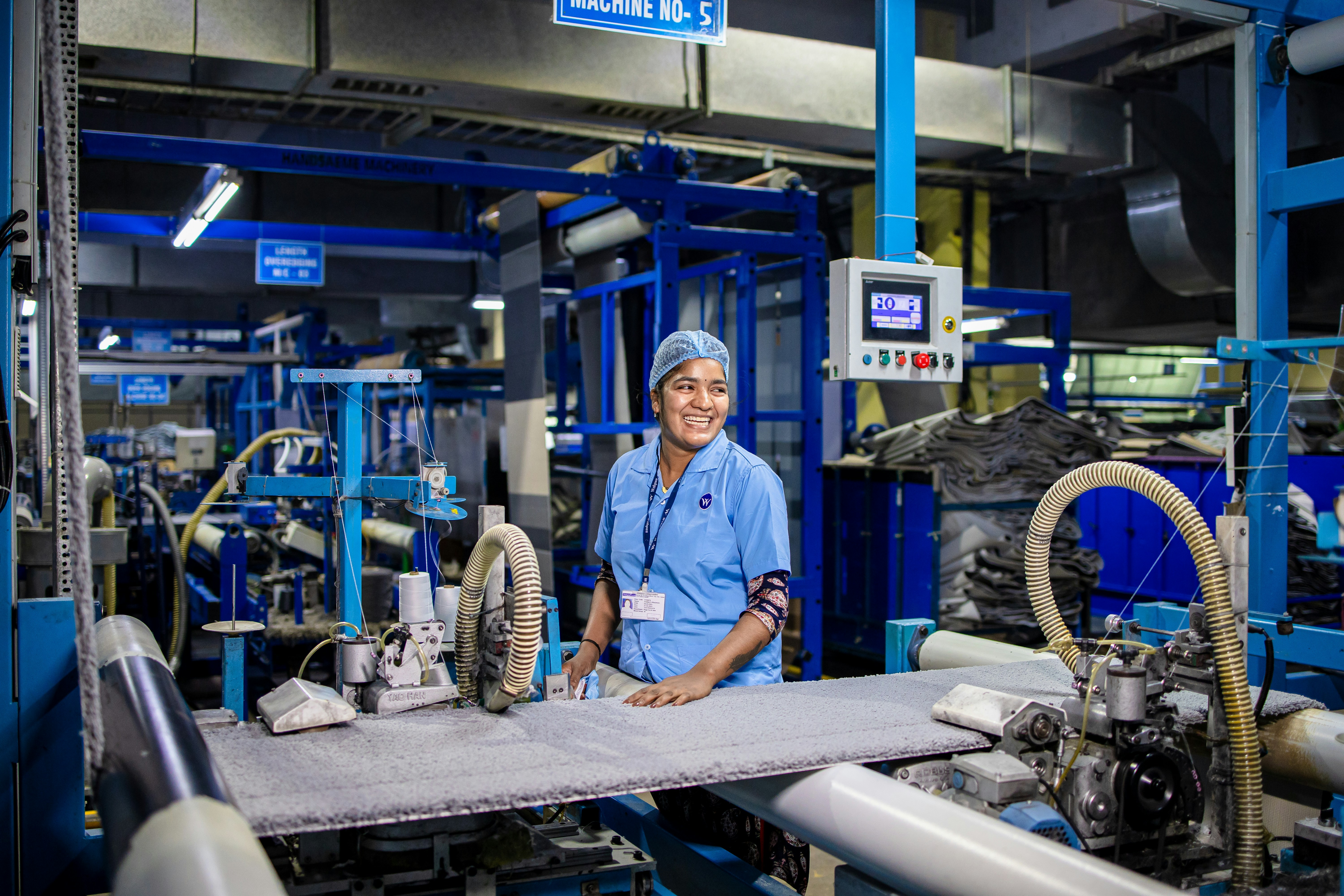 A smiling woman works in a factory. photo – Free Worker Image on Unsplash