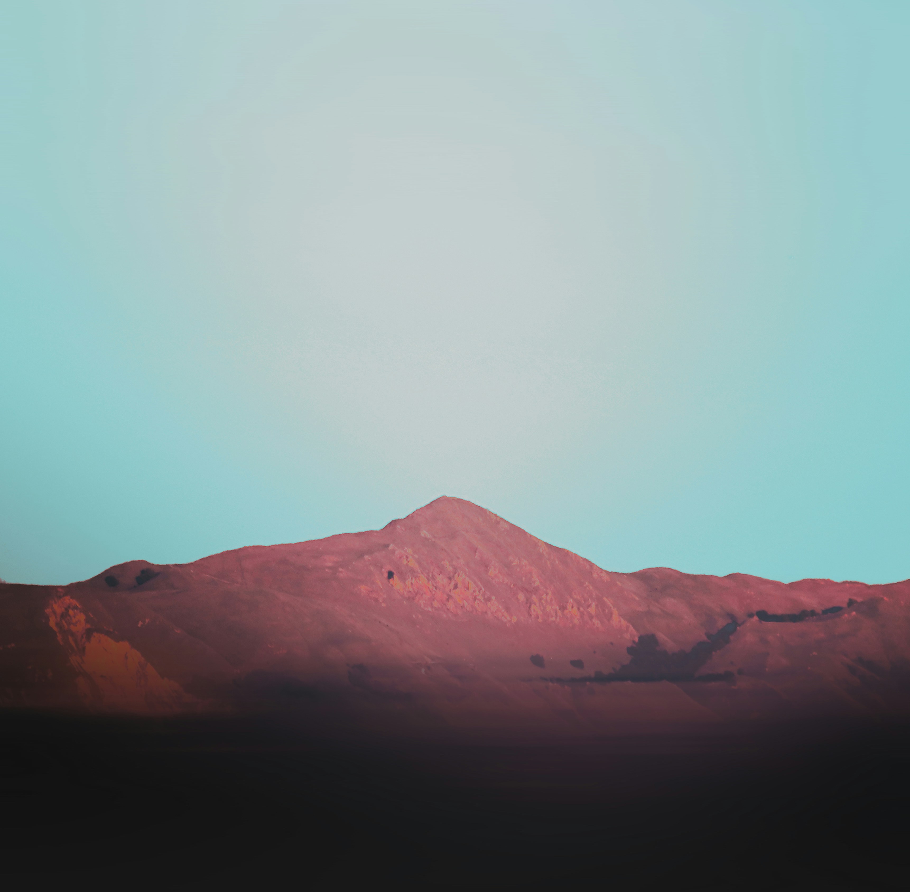 Red mountain under a pale turquoise sky. photo – Free Scenery Image on ...