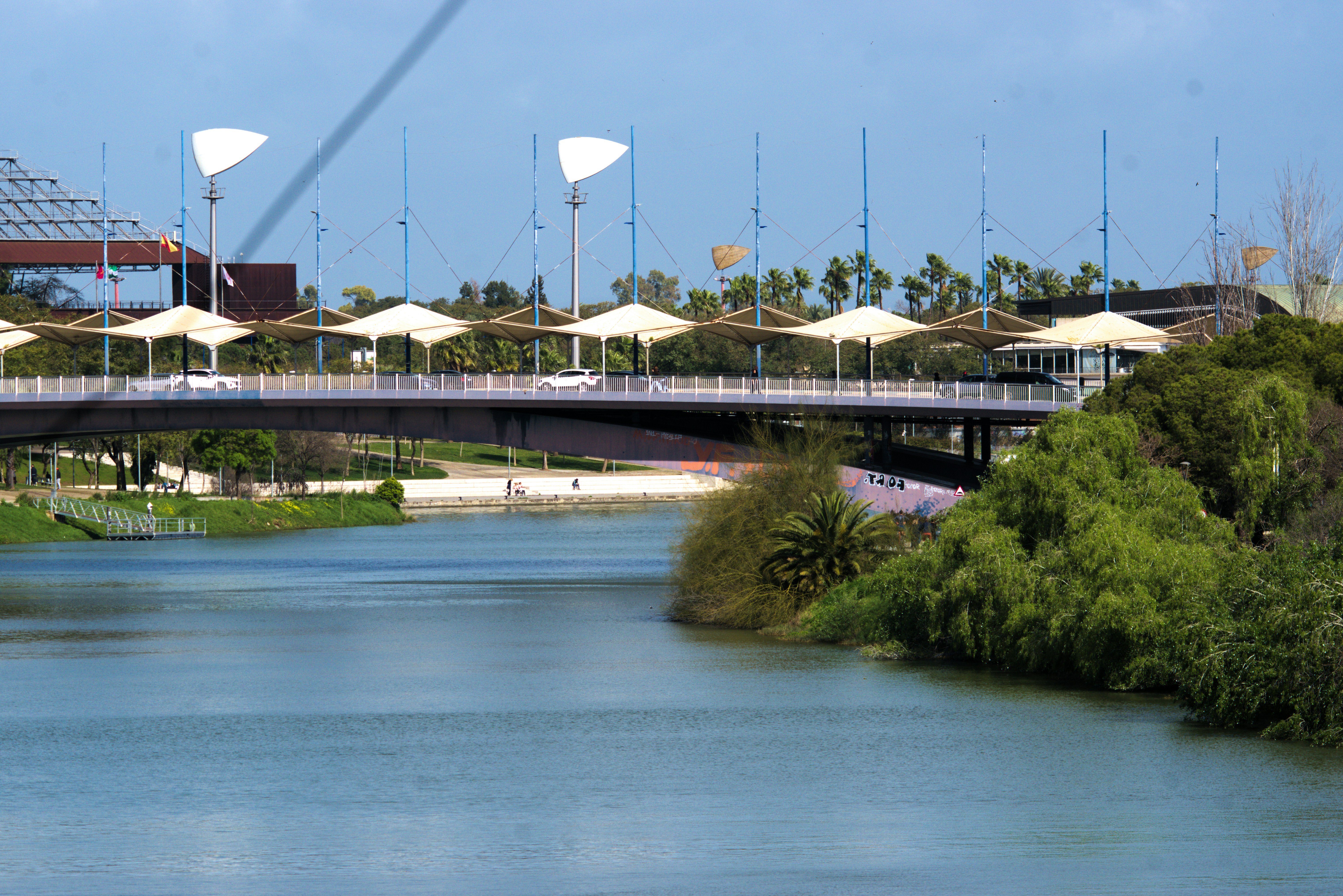A bridge spans over the water with modern architecture. photo – Free ...