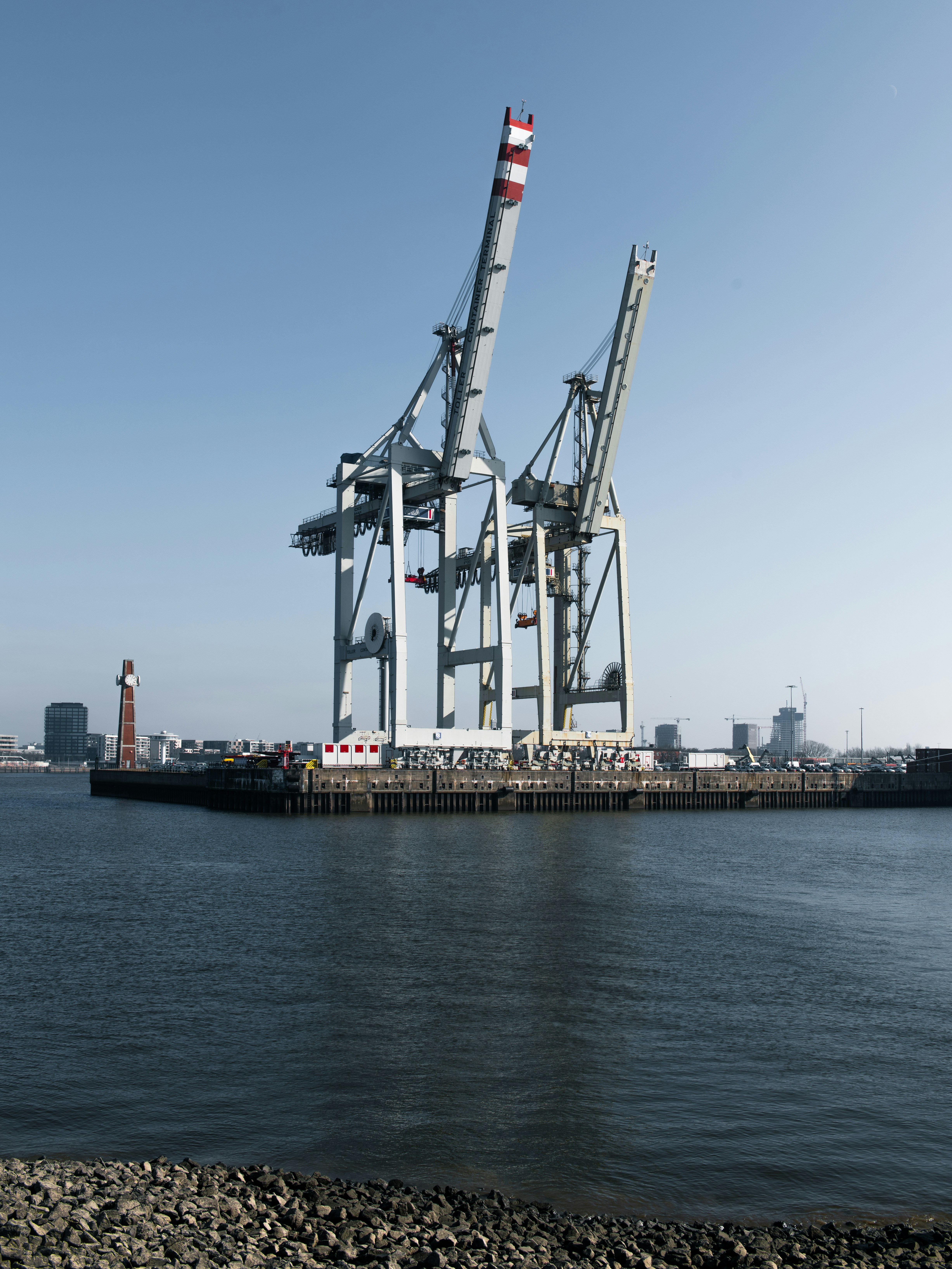 Large cranes stand tall over the water. photo – Free Transport Image on ...