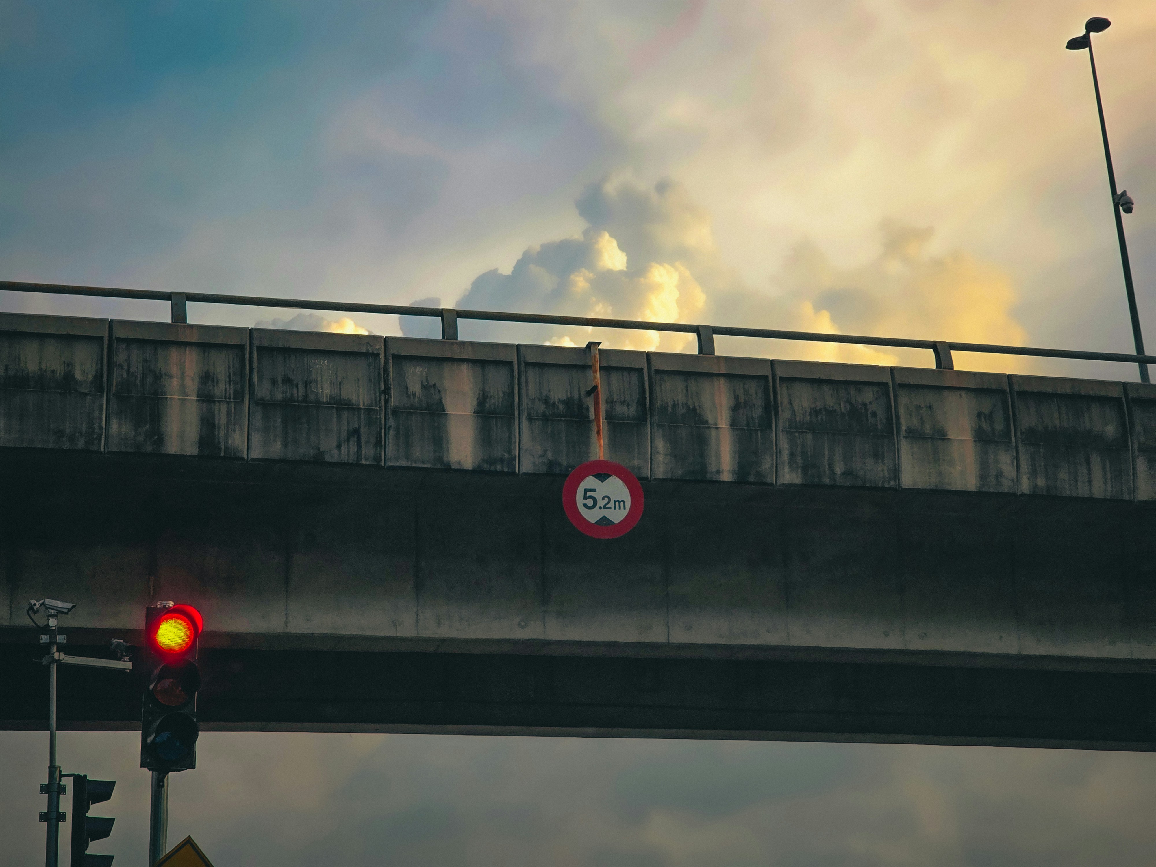 An overpass with a traffic light and a sign. photo – Free Wallpaper ...