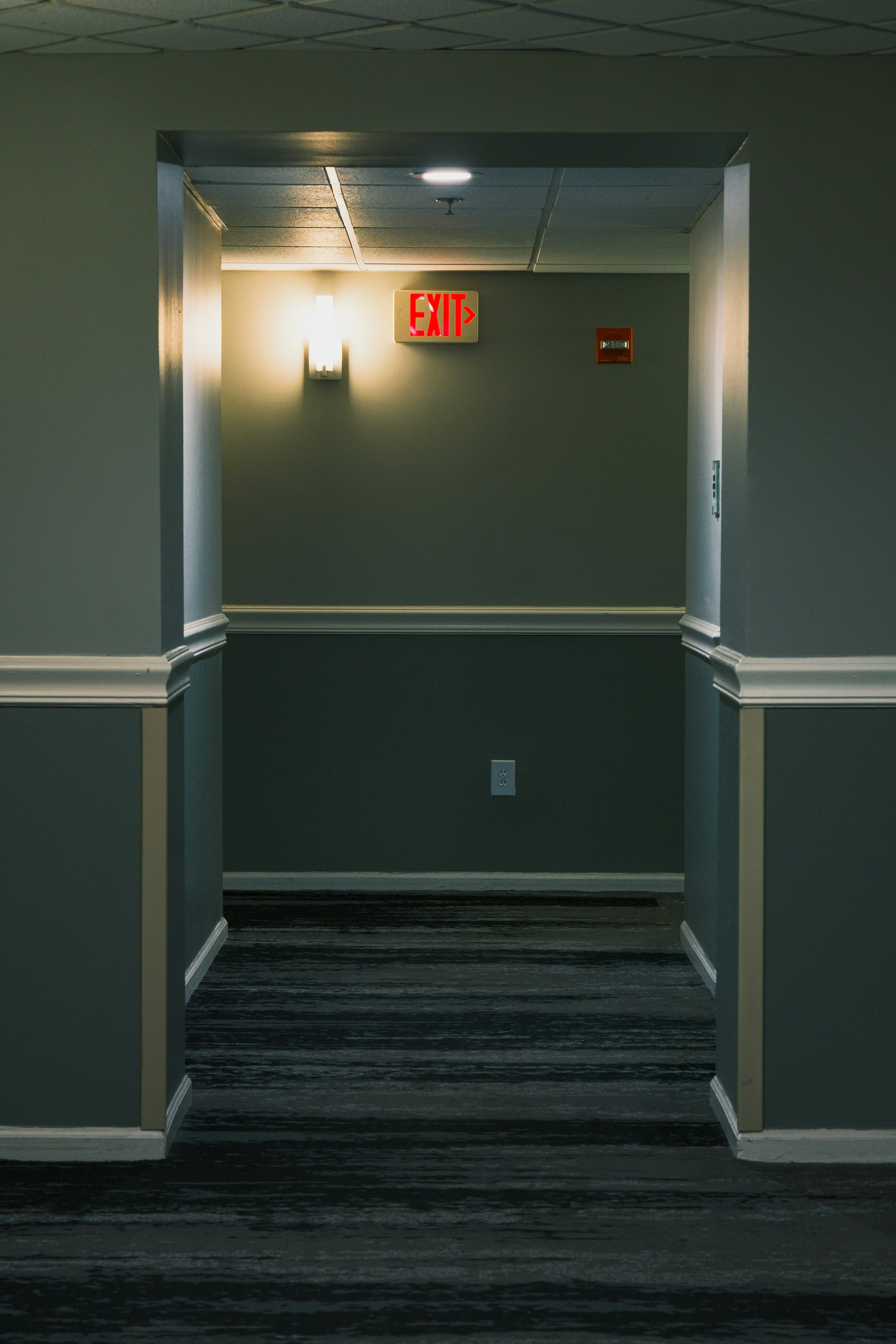 A hallway with an exit sign is visible. photo – Free Building Image on ...