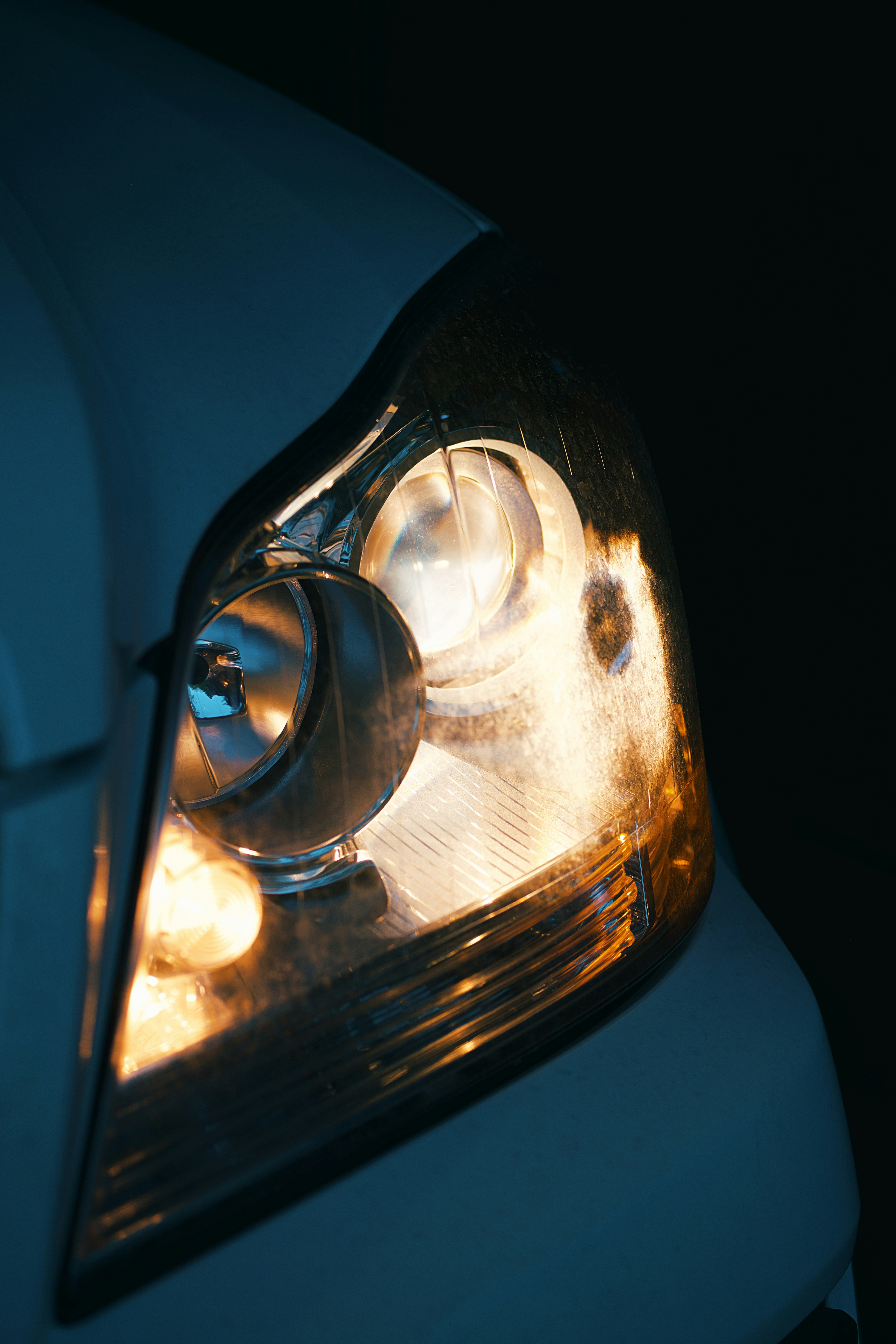 Amber Lantern in the Night: Close-Up of a Car Headlight's Quiet Power