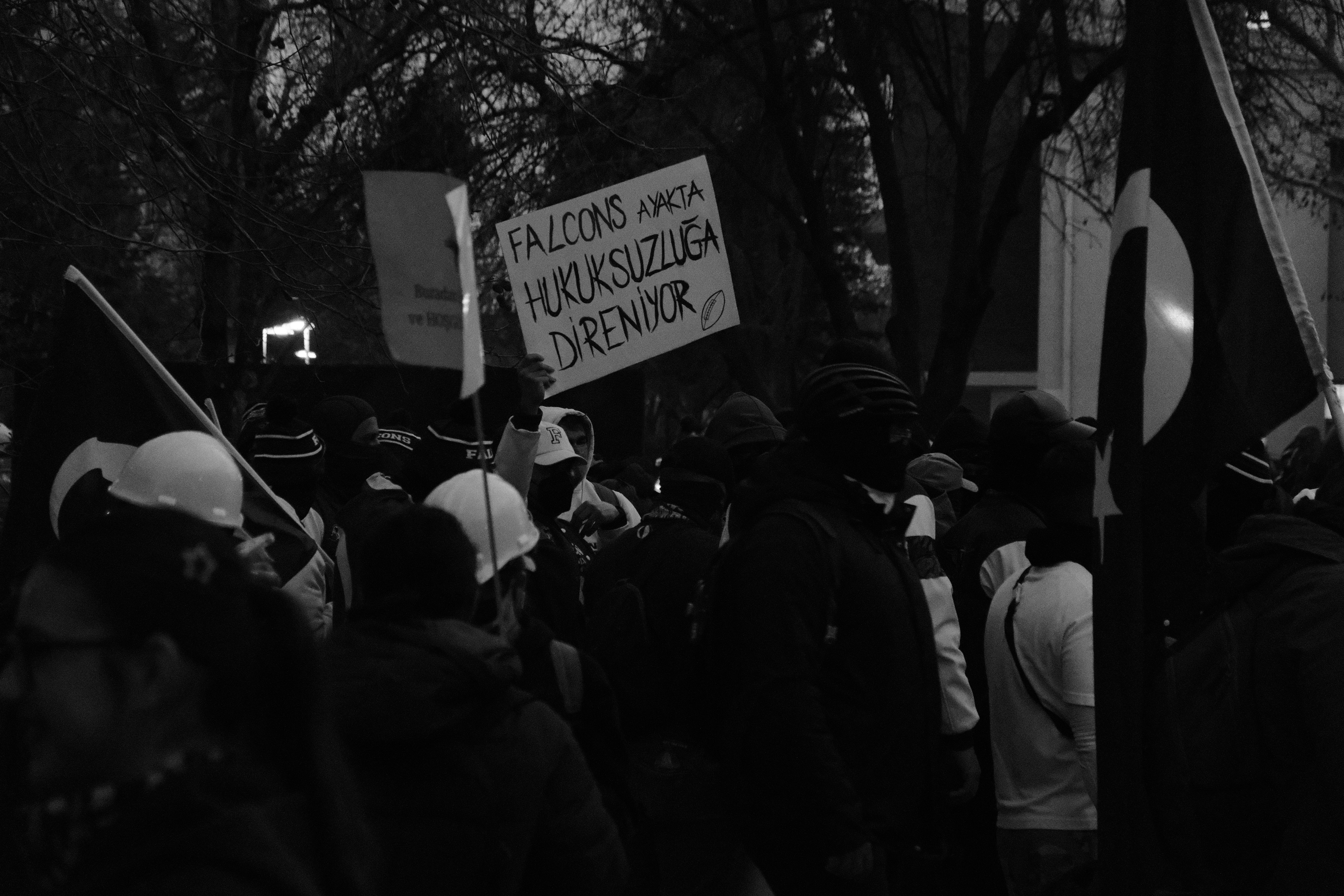 Protesters march holding signs in a grayscale image. photo – Free Human ...