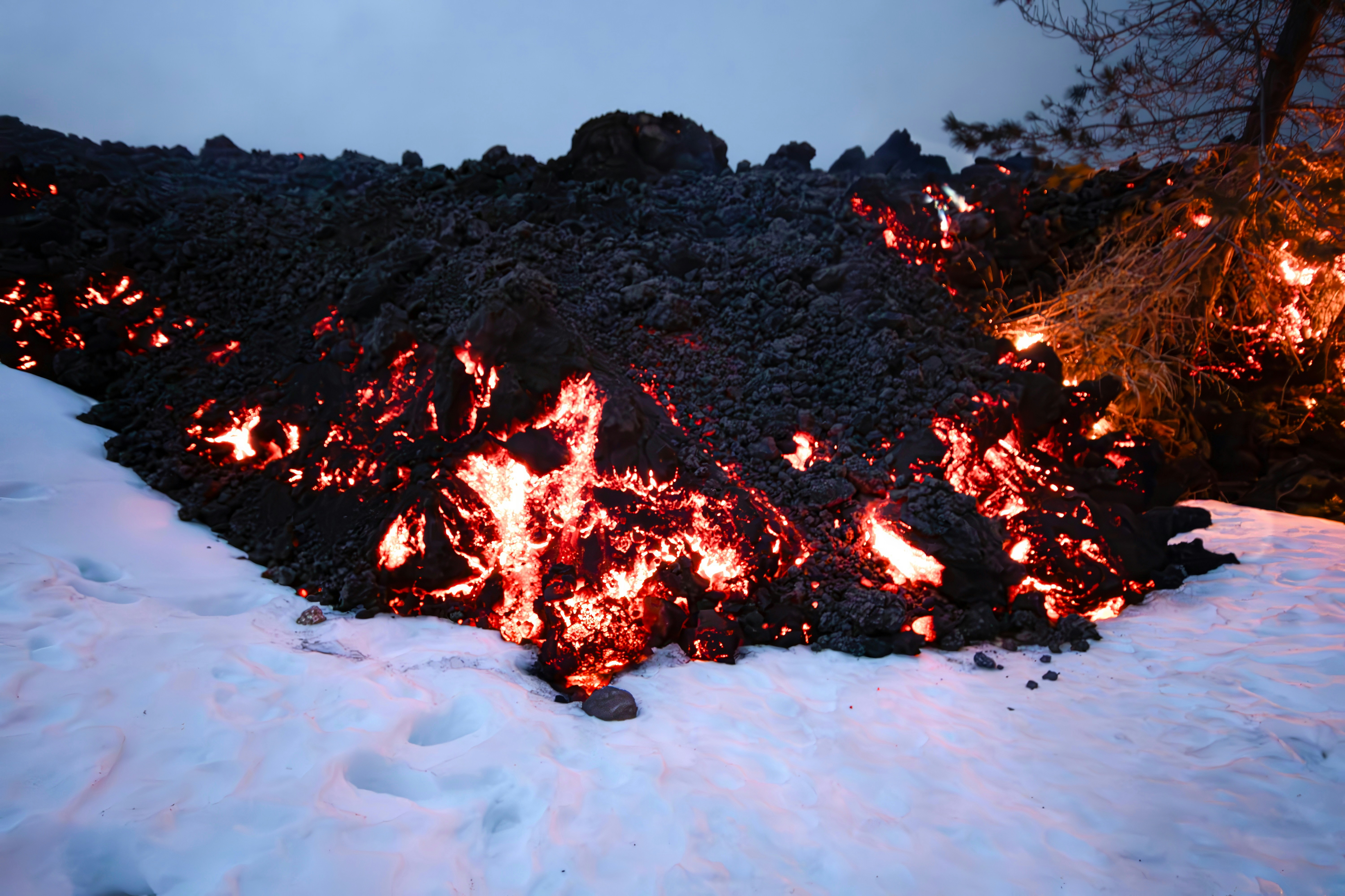 Burning lava flows on a snowy landscape. photo – Free Fire Image on ...