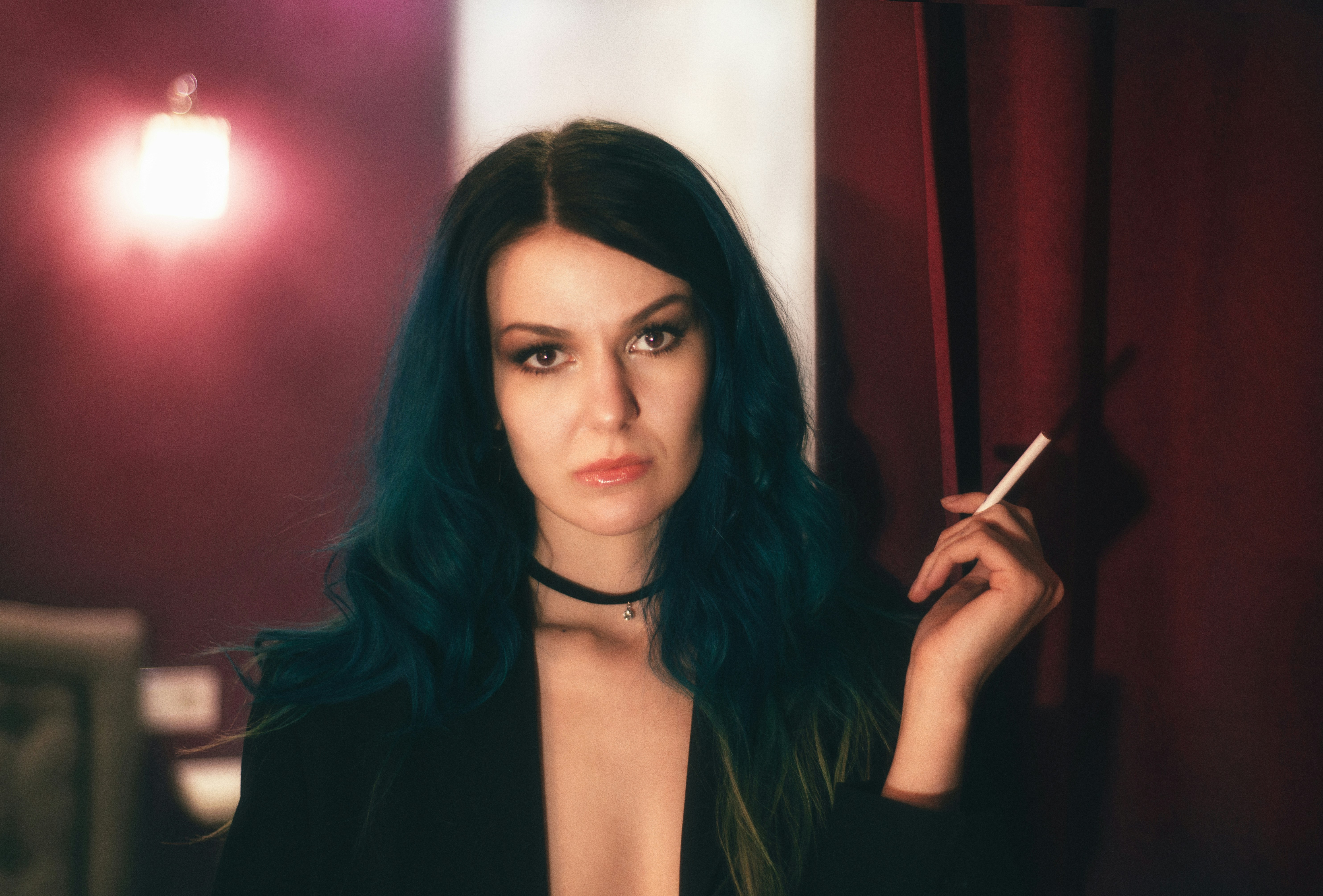 Neon Velvet Portrait: Contemplation in Crimson Backstage Light
