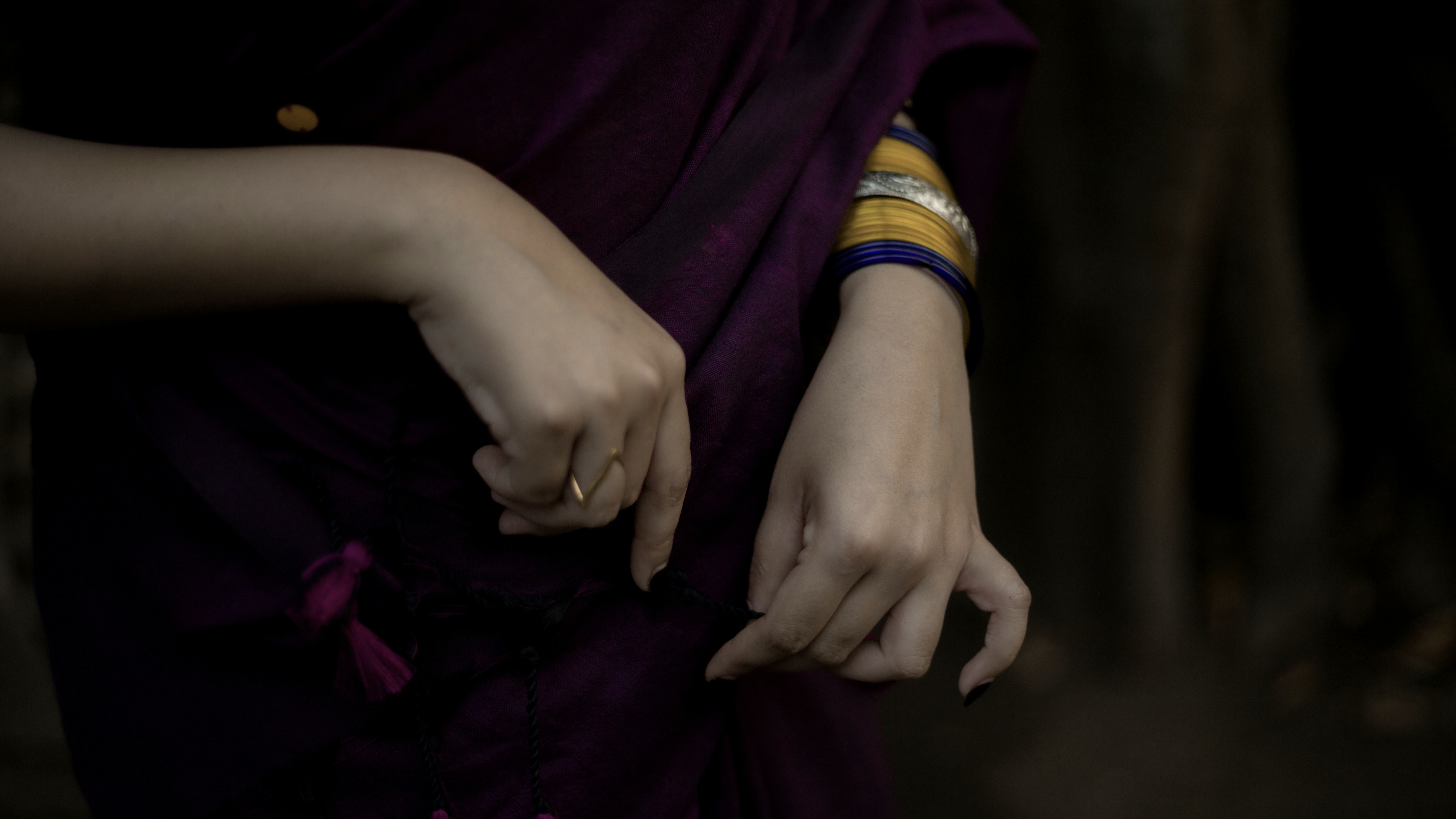 Woman's hands and sleeves are visible in the image.